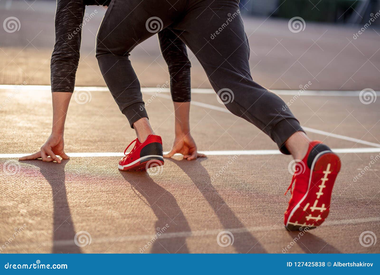 Man Feet in Starting Position for Running on Race Track in Stadium ...