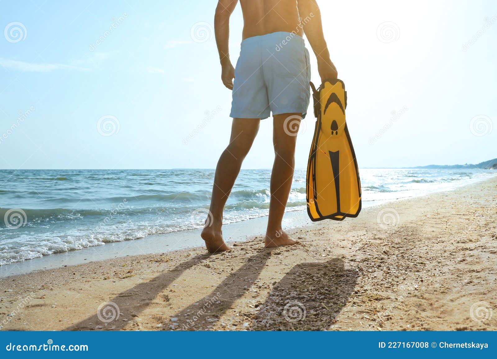 Back View of Man with Flippers Walking on Beach, Closeup Stock Photo ...