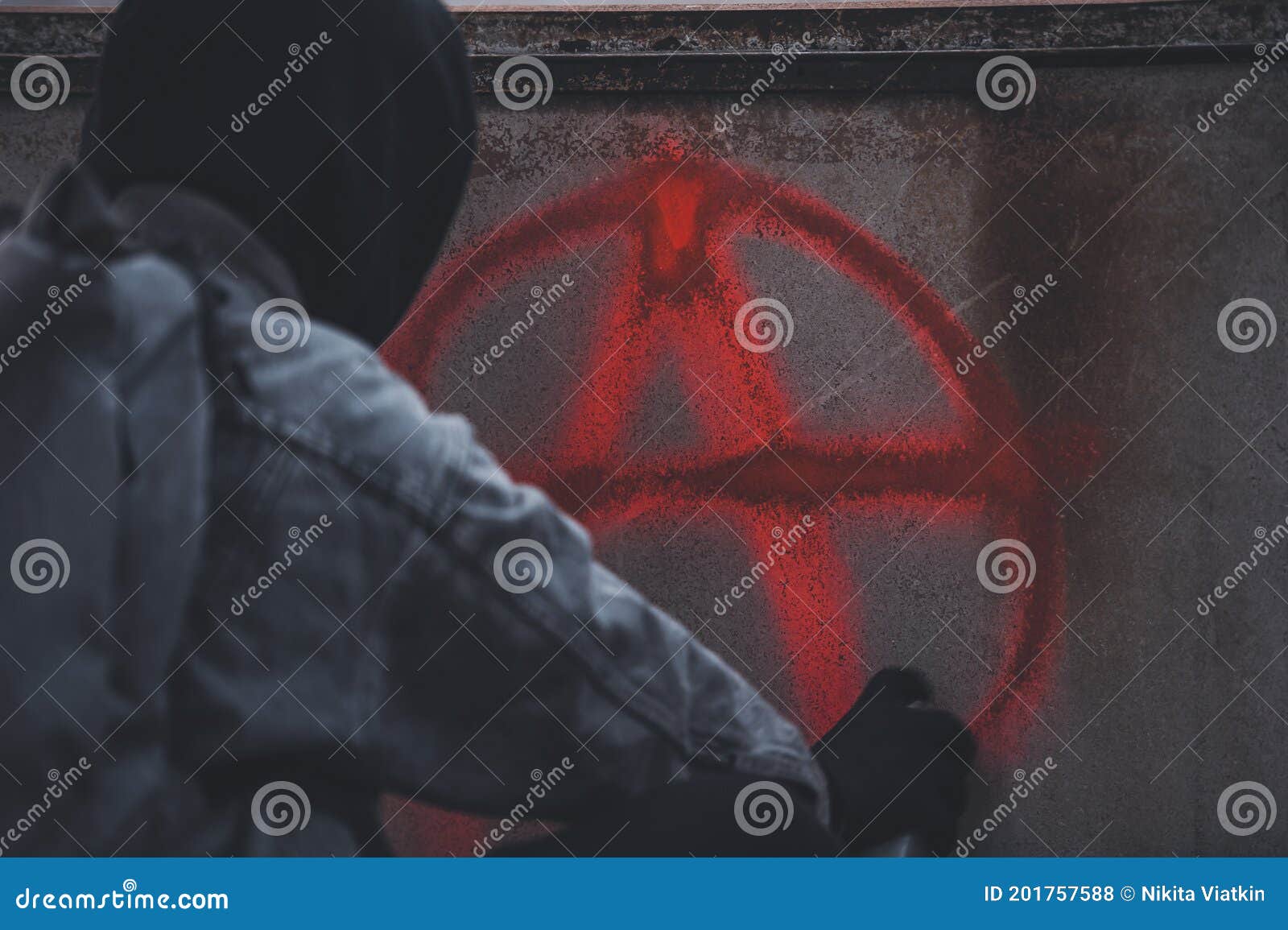 Back View of Man in Hood Who Paint Anarchy Symbol on the Wall Stock ...