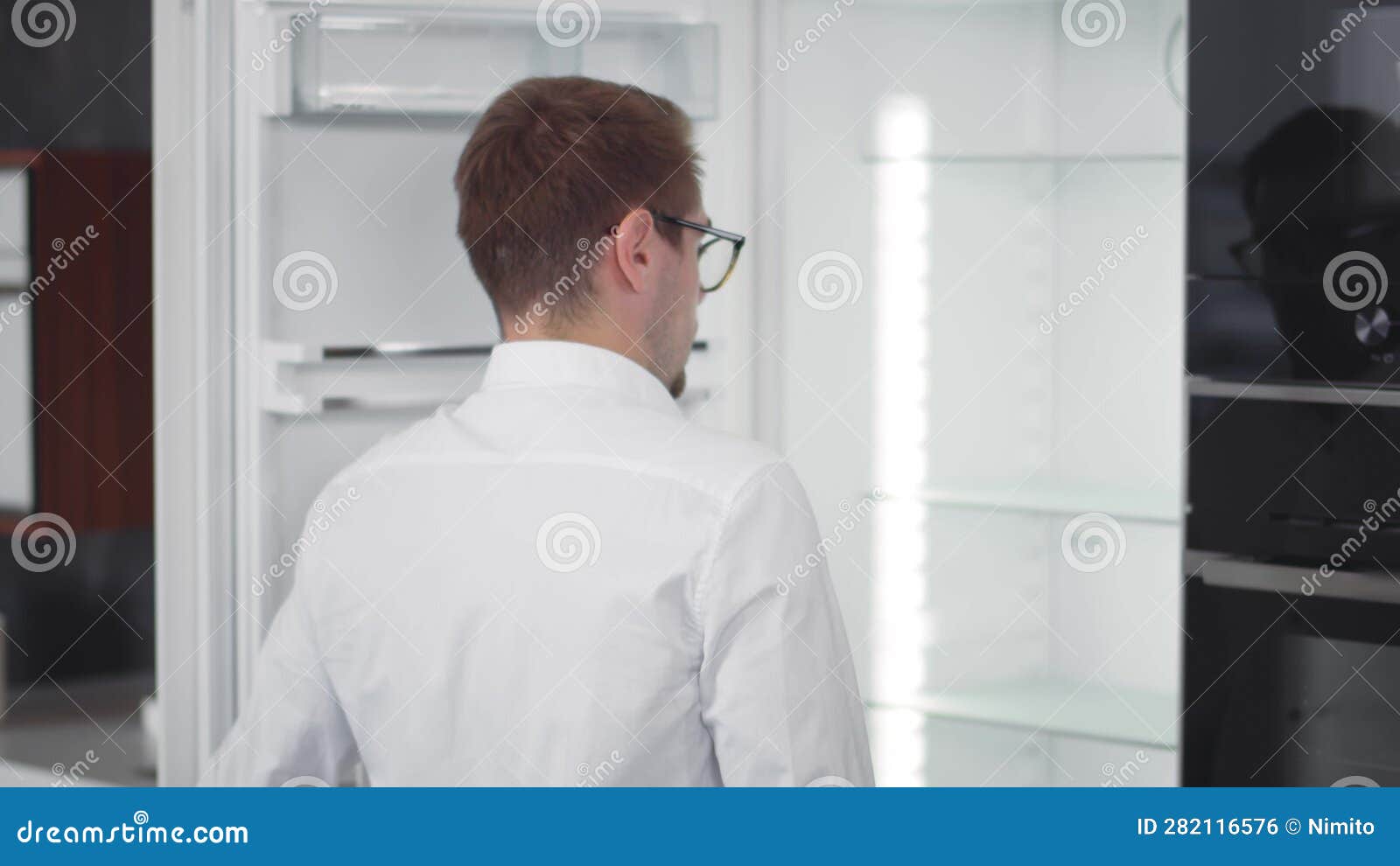 Back View of Man Look into Empty Refrigerator. Realtime Stock Footage ...
