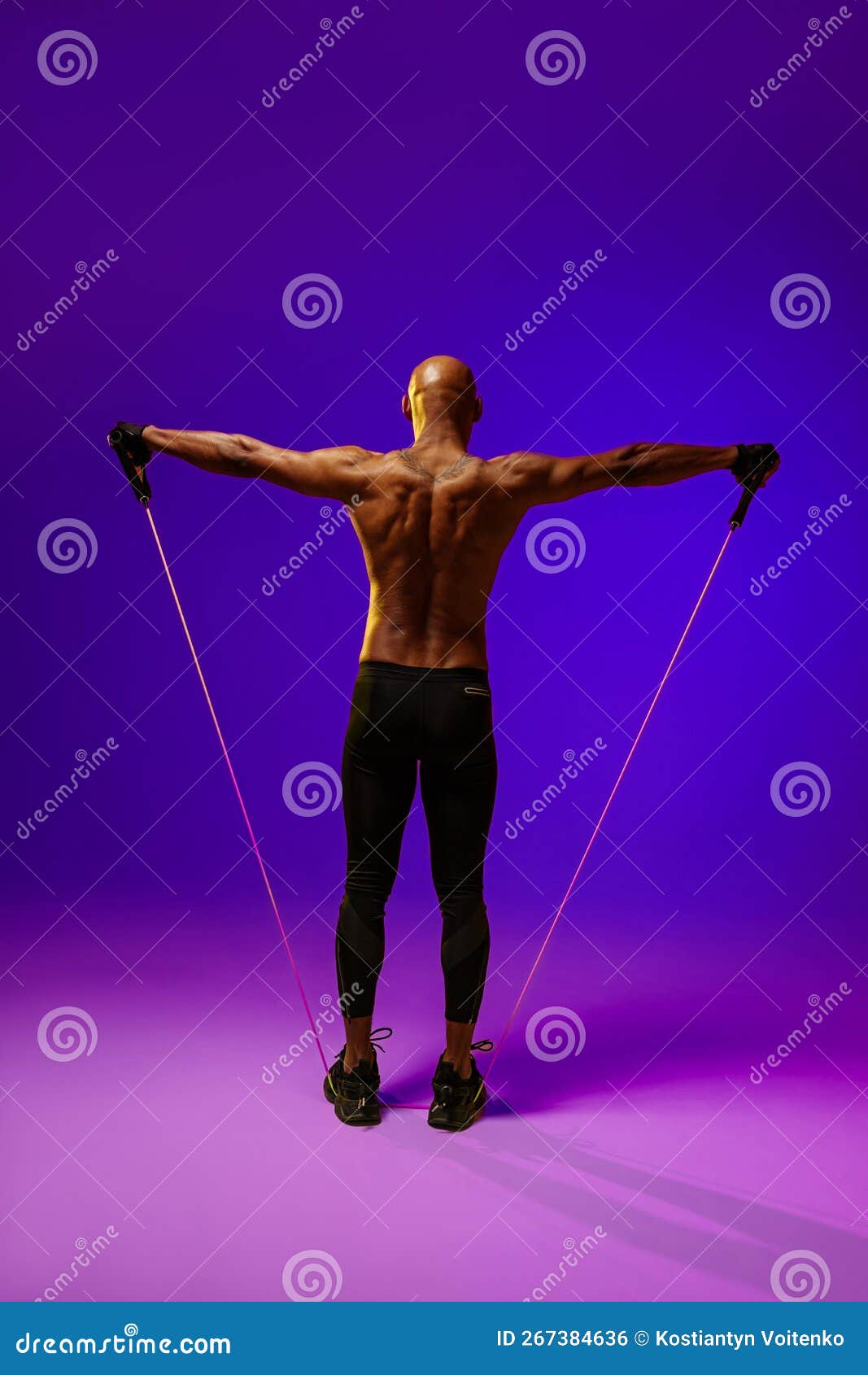 Back View of Man Performs Exercises with Expander on Studio Background ...