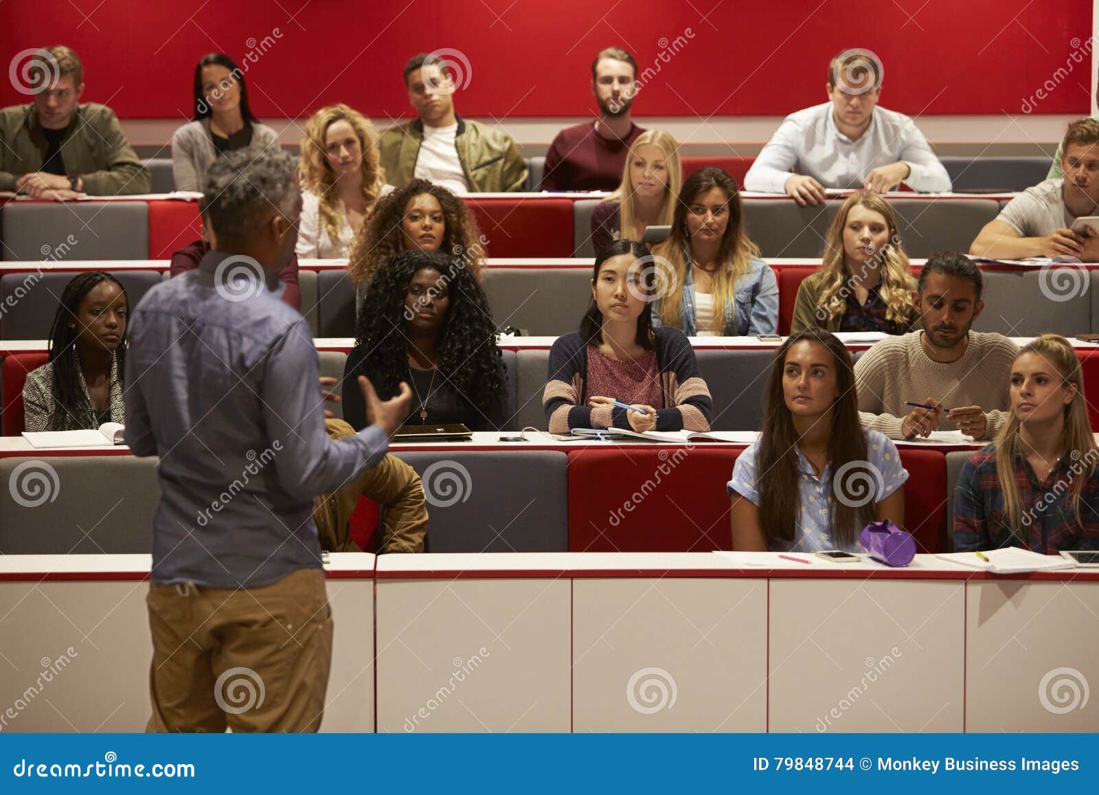 Back View of Man Presenting To Students at a Lecture Theatre Stock ...
