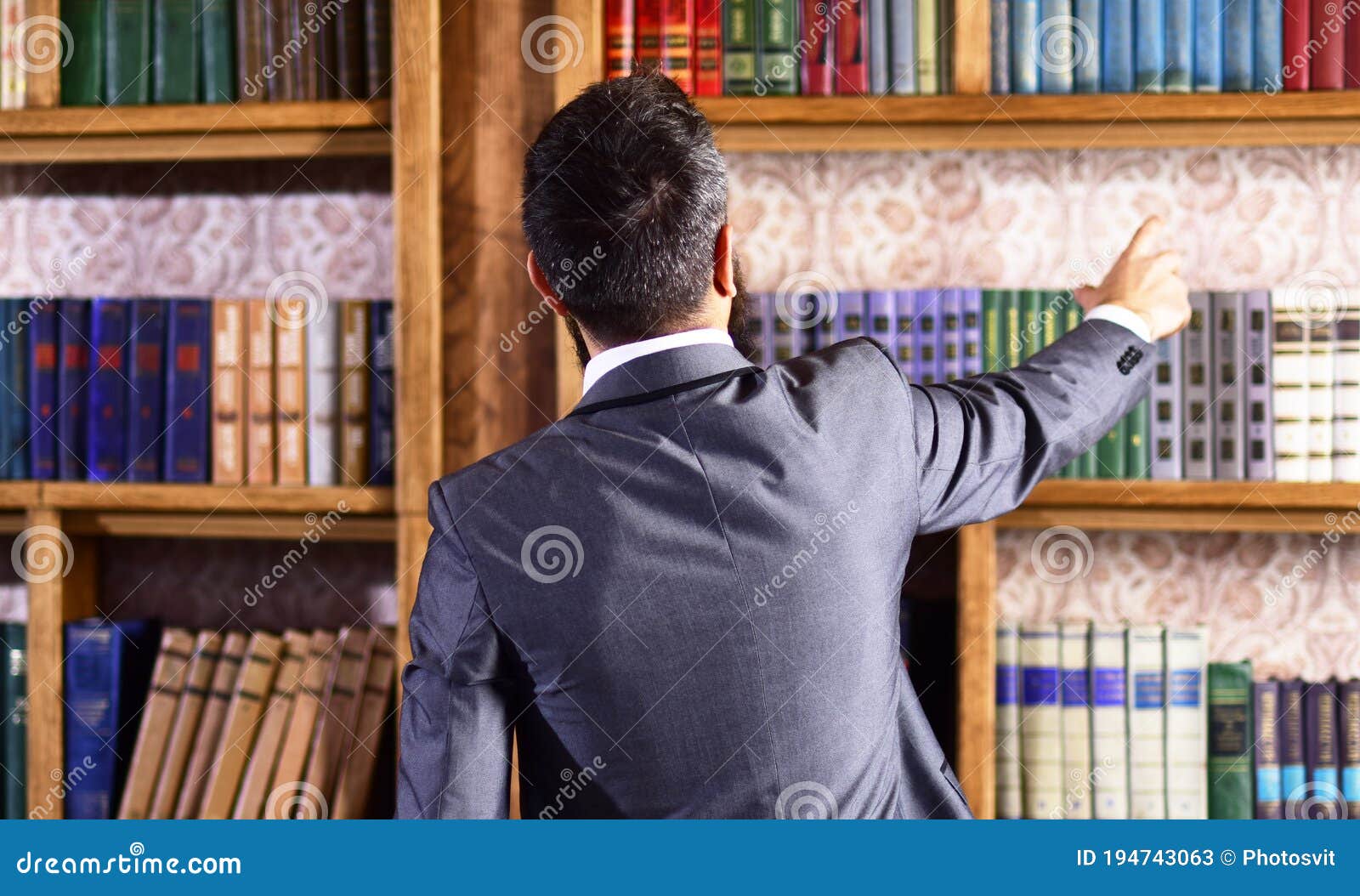 Back View of Man Standing and Searching Book in Library Stock Image ...