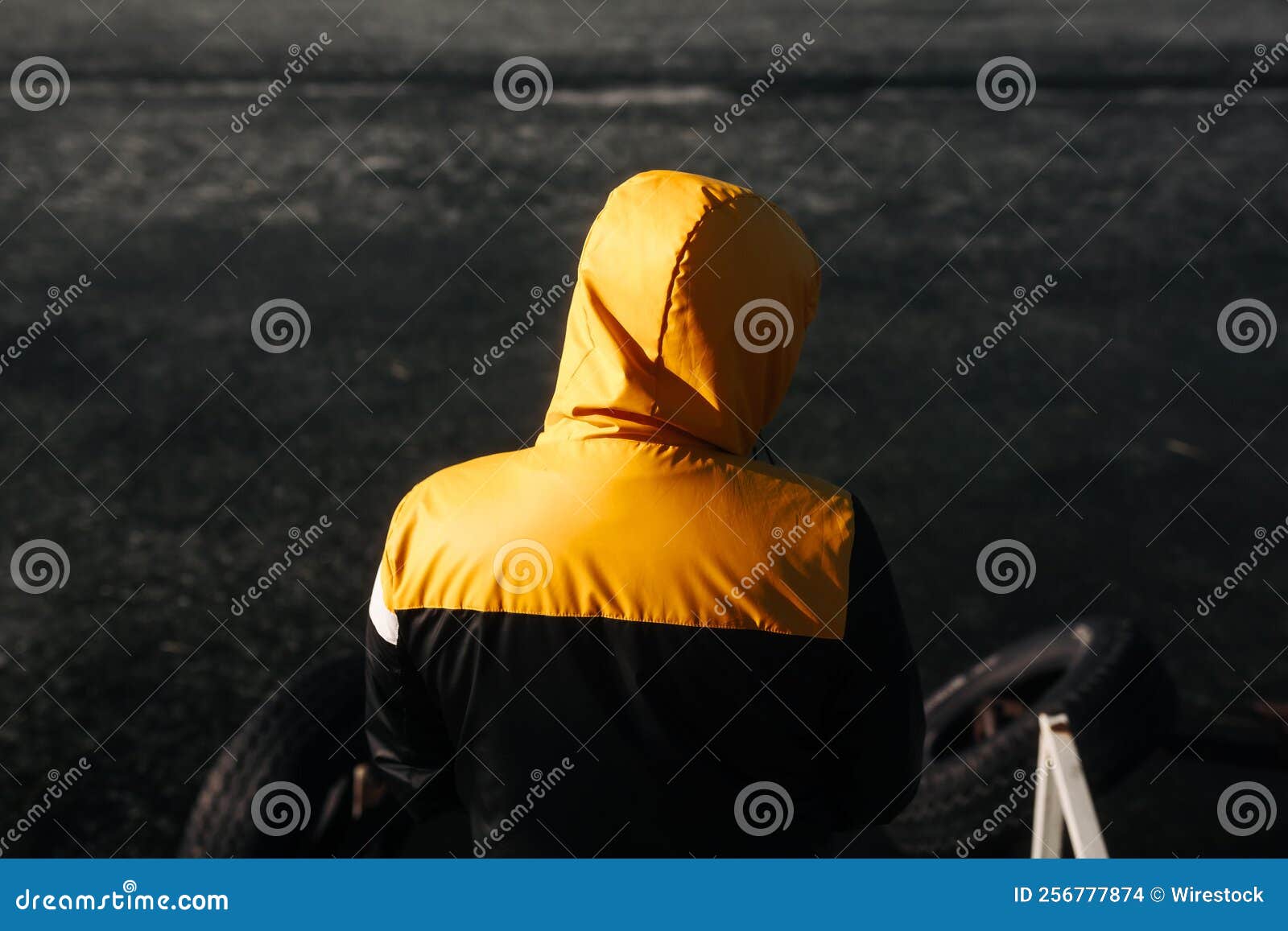 Back View of a Man Wearing a Yellow Hooded Jacket Stock Photo - Image ...