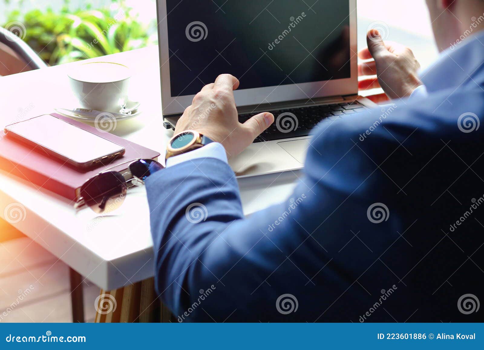 Back View of a Man Working at a Laptop, Typing on the Keyboard while ...