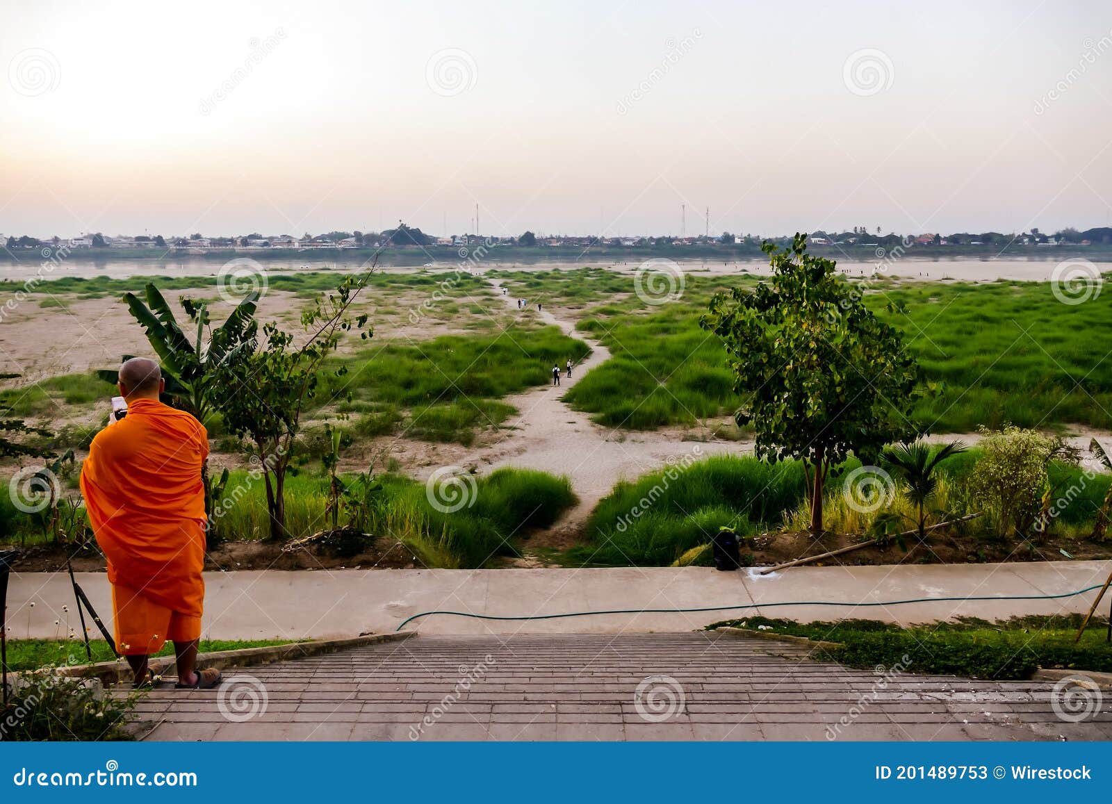 Back View of a Monk in an Orange Cloth Looking at Nature Editorial ...