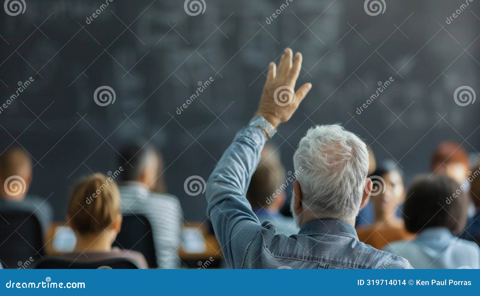 Back View of Older Student Raising His Hand To Answer Teacher S ...