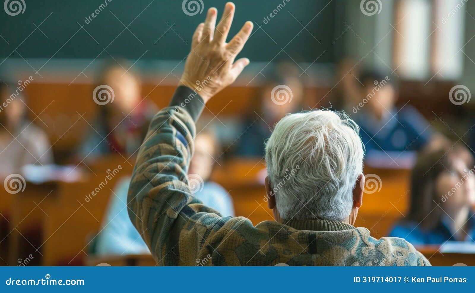 Back View of Older Student Raising His Hand To Answer Teacher S ...