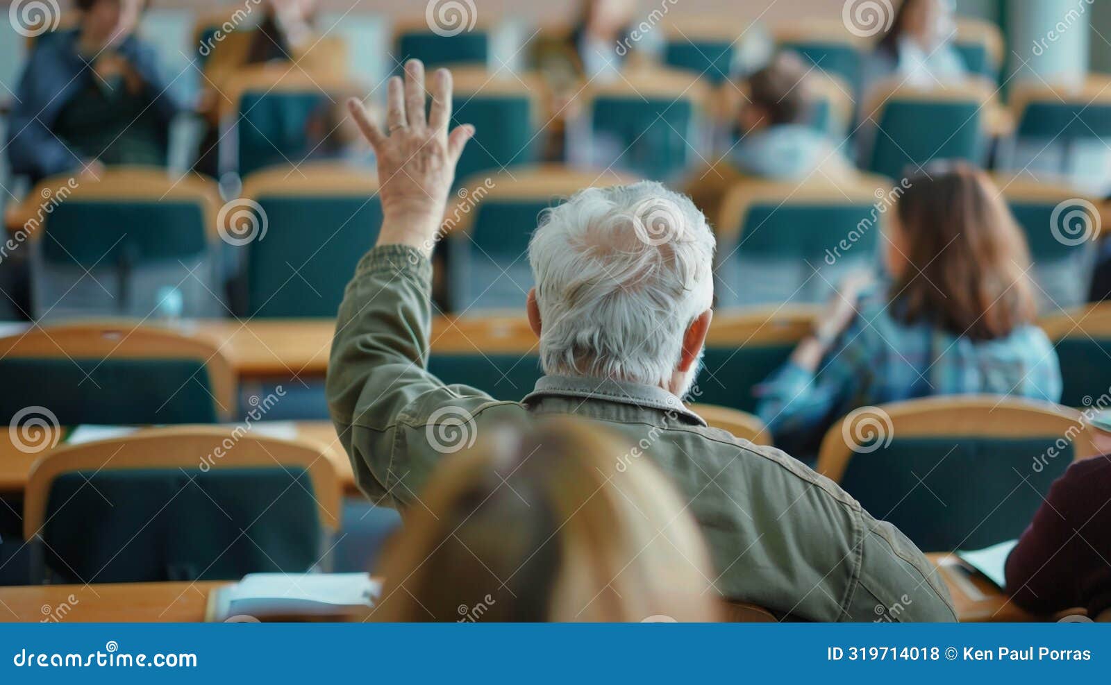Back View of Older Student Raising His Hand To Answer Teacher S ...
