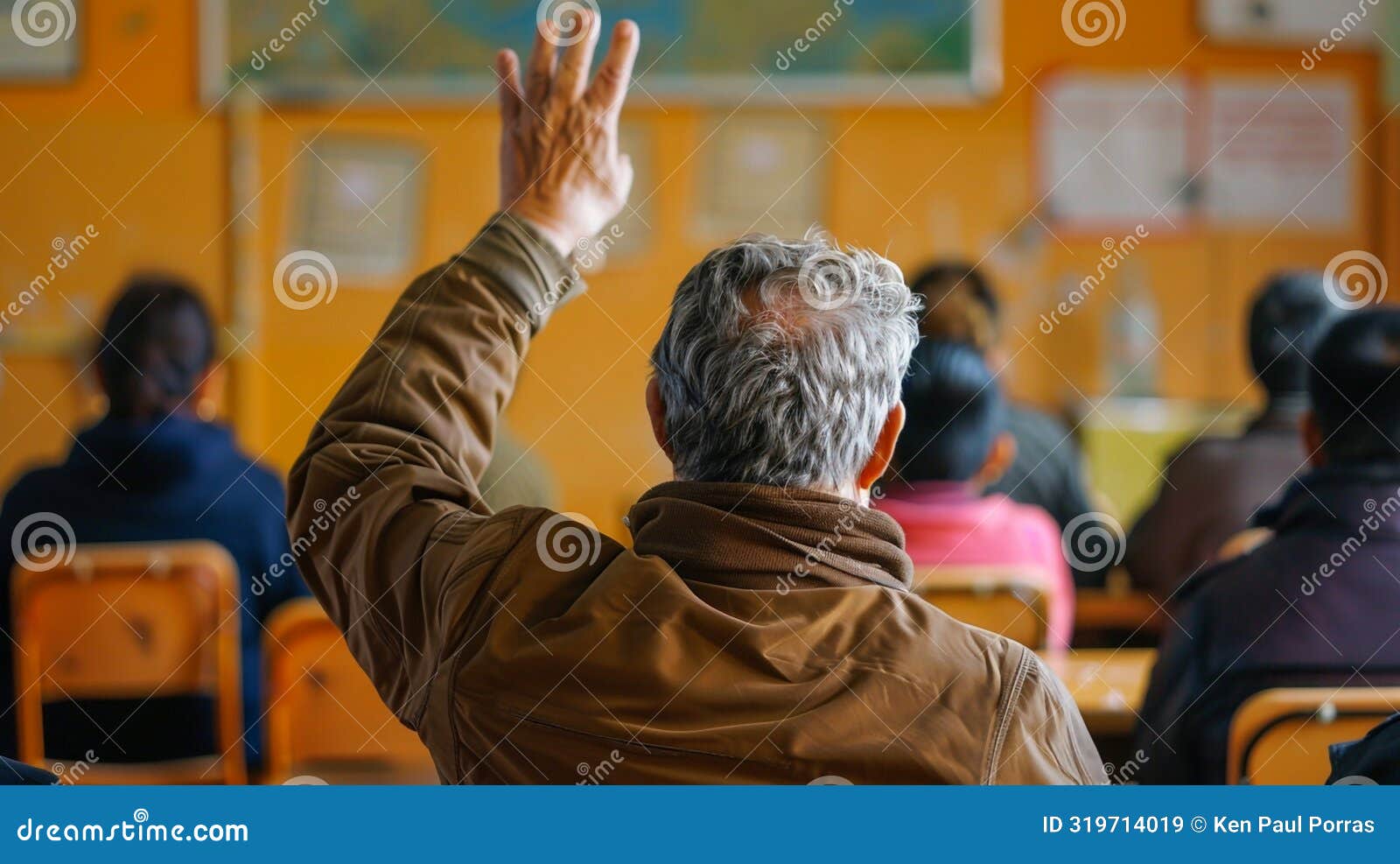 Back View of Older Student Raising His Hand To Answer Teacher S ...