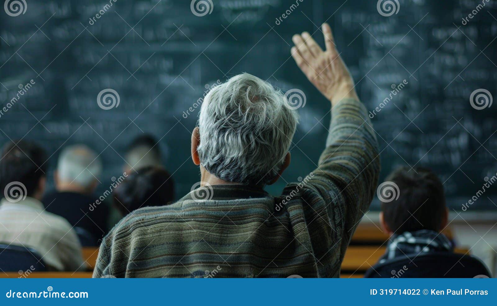 Back View of Older Student Raising His Hand To Answer Teacher S ...