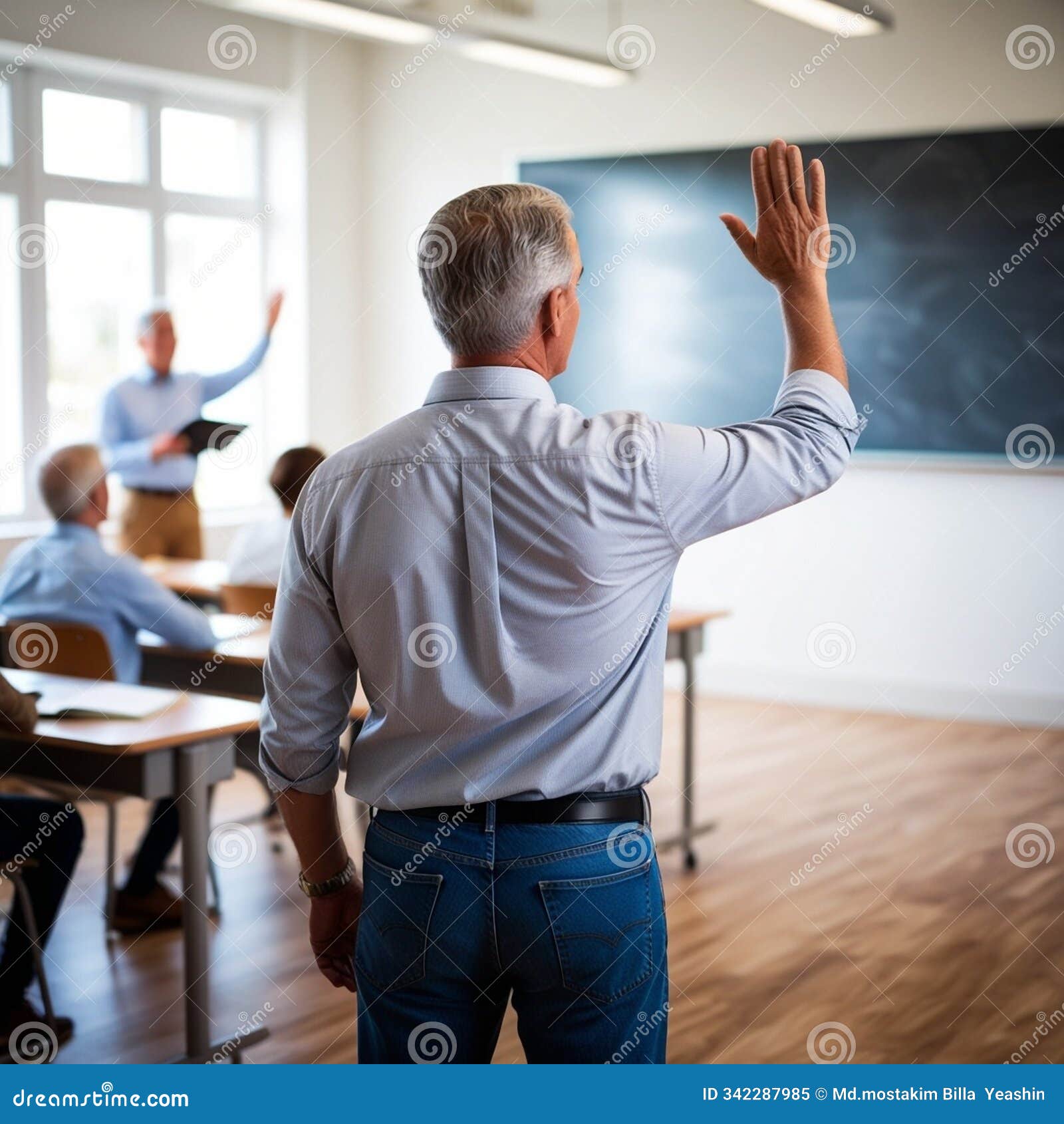 Back View of Older Student Raising His Hand To Answer Teacher S ...