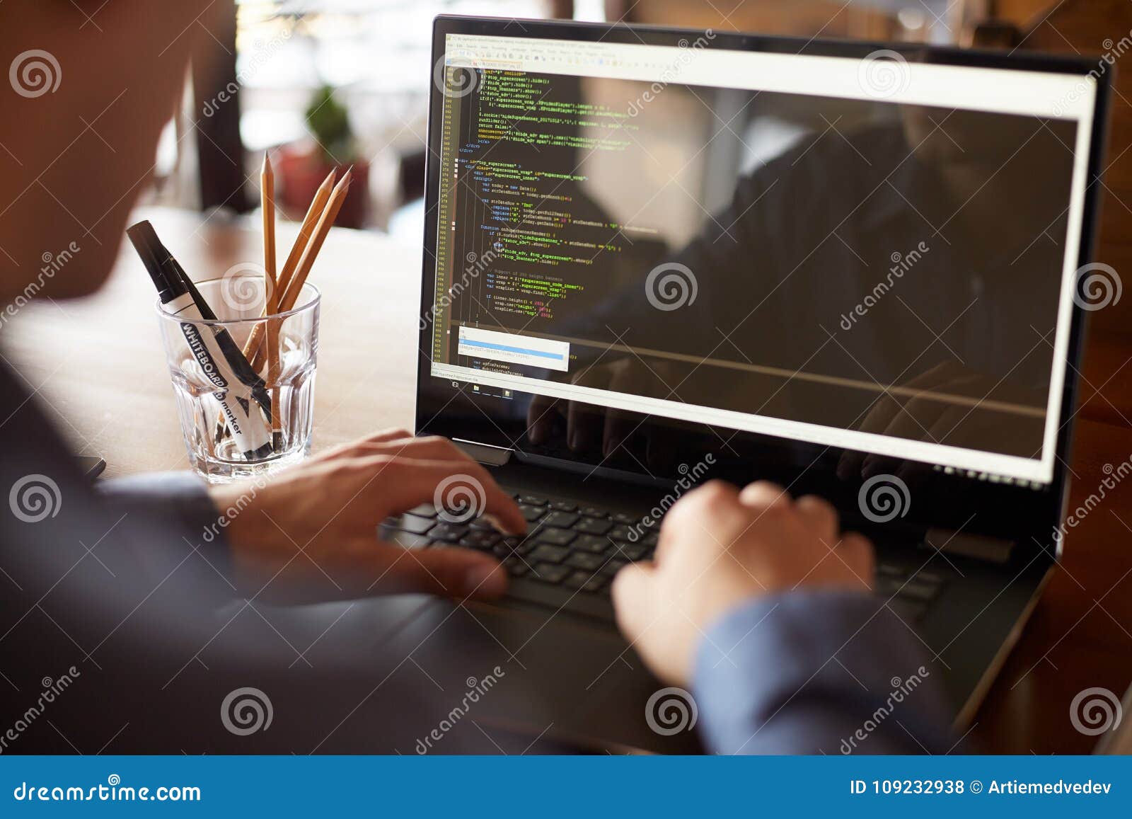 Back View Over the Shoulder Shot of Developer Programmer with Laptop ... Back View Over the Shoulder Shot of Developer Programmer with Laptop ...