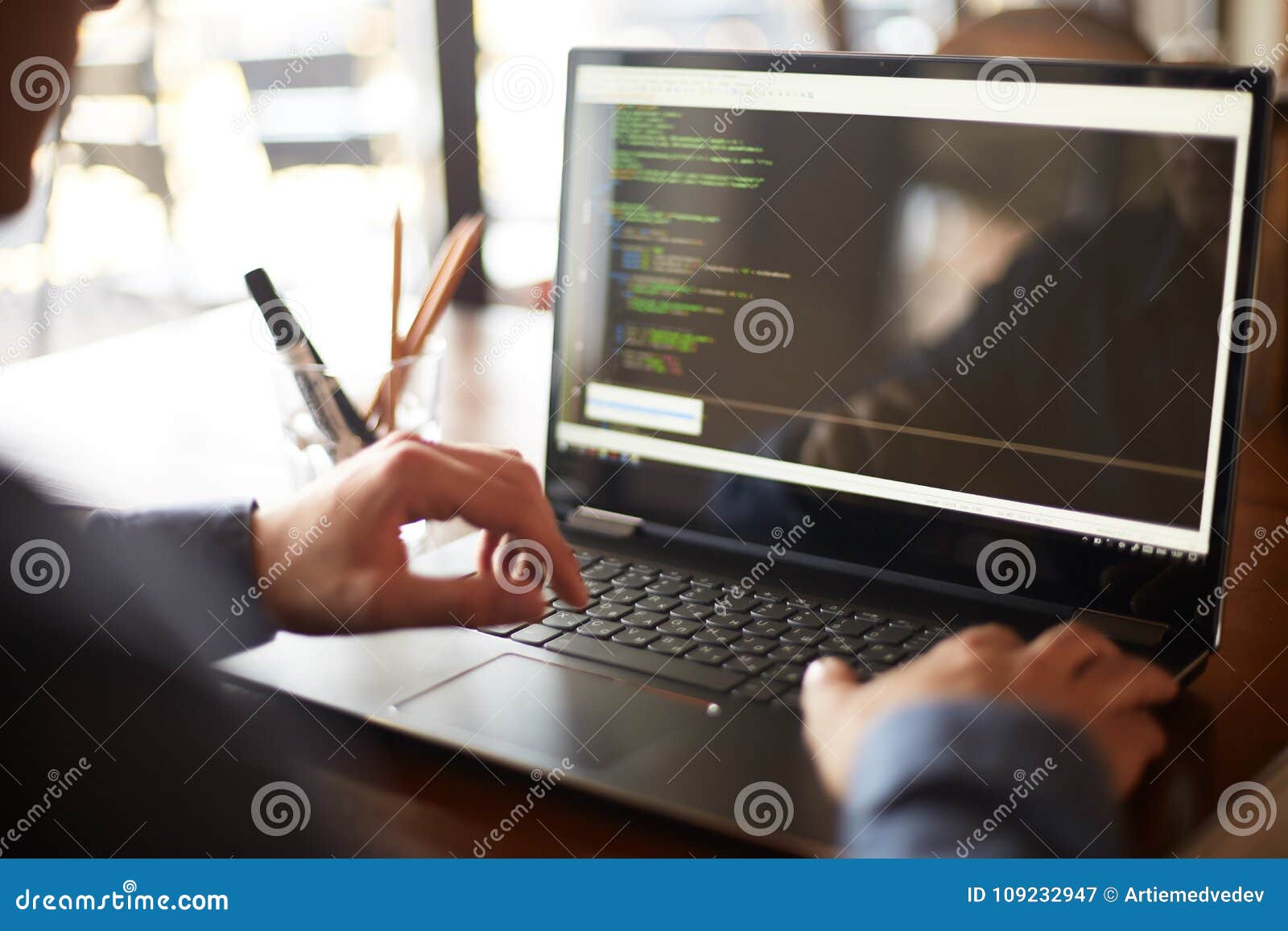 Back View Over the Shoulder Shot of Developer Programmer with Laptop ... Back View Over the Shoulder Shot of Developer Programmer with Laptop ...
