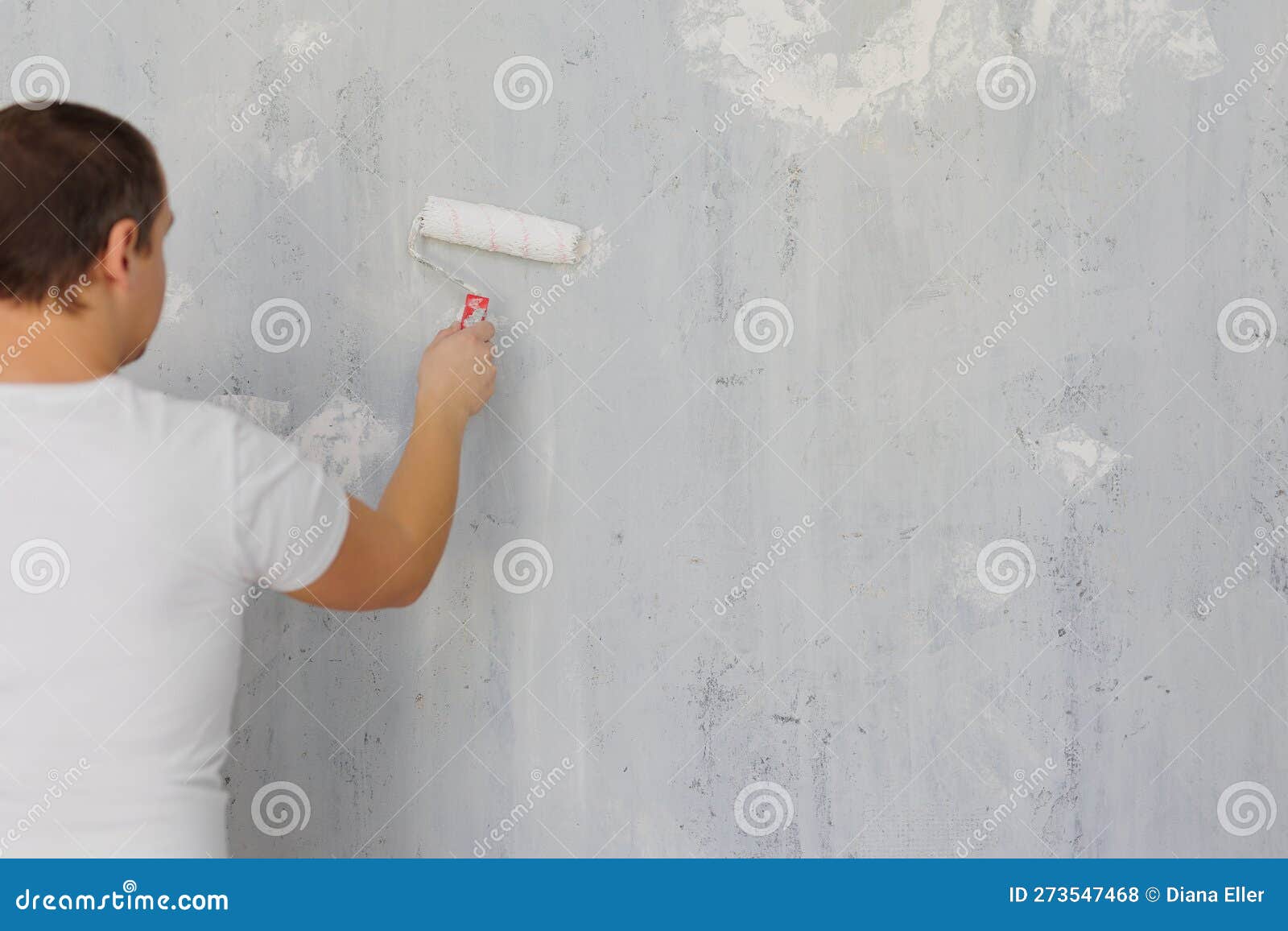 Back View of Painter Man Painting the Wall with Paint Roller Stock ...