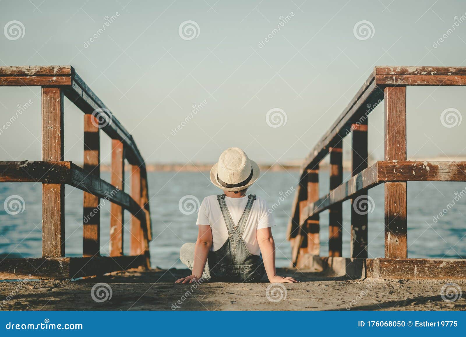 Back View of a Pensive Child Sitting Looking at the Sea Stock Photo ...