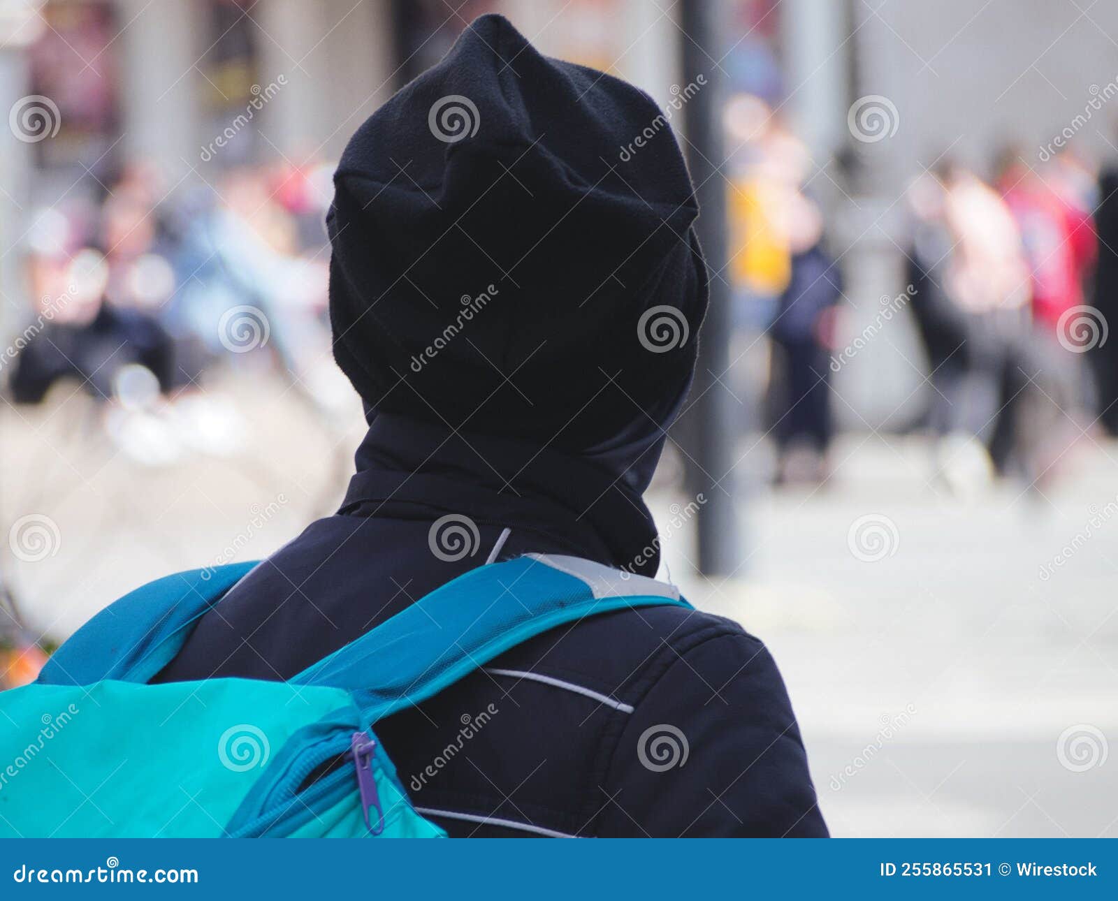 Back View of a Person with a Black Hat and a Blue Backpack Stock Image ...