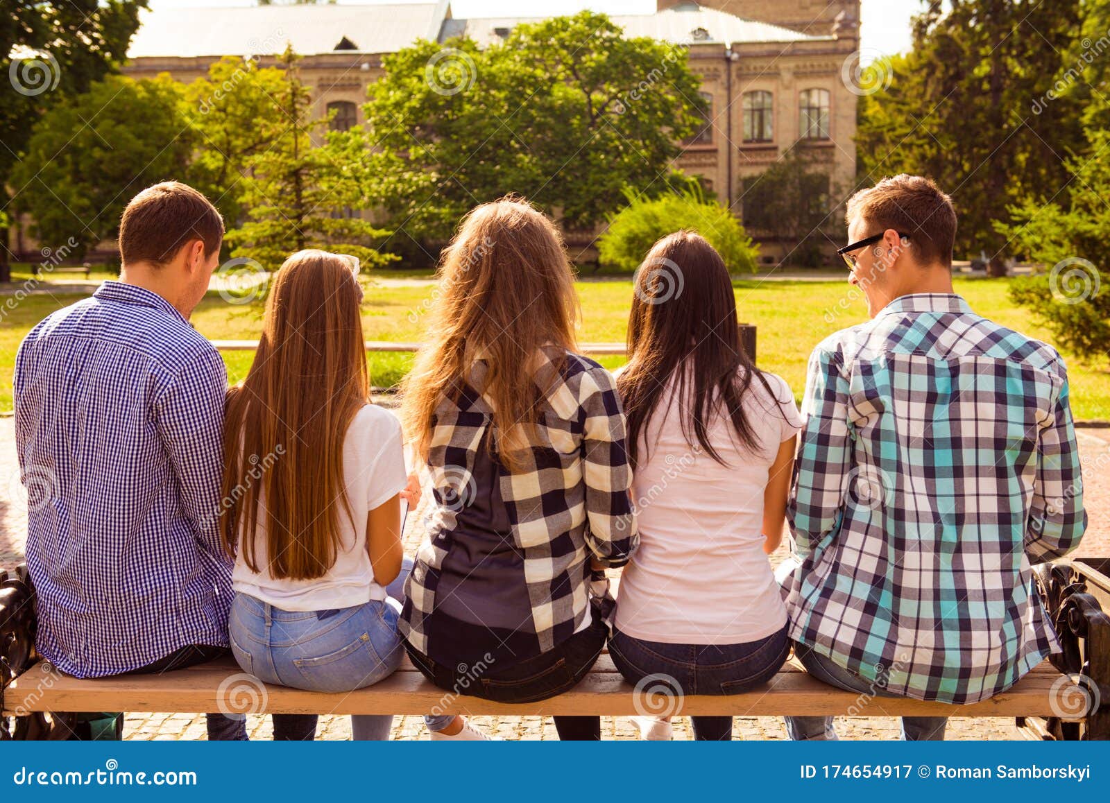 Back View Photo of Five Diverse Students Sitting on Bench and Study Up ...