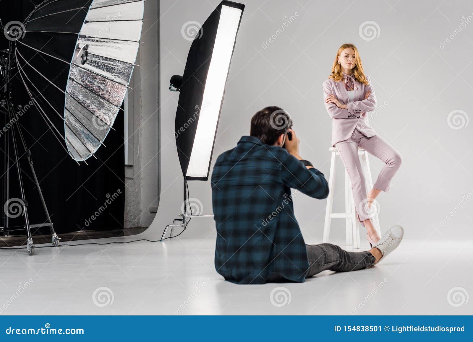 Back View of Photographer Sitting and Shooting Beautiful Female Model ...