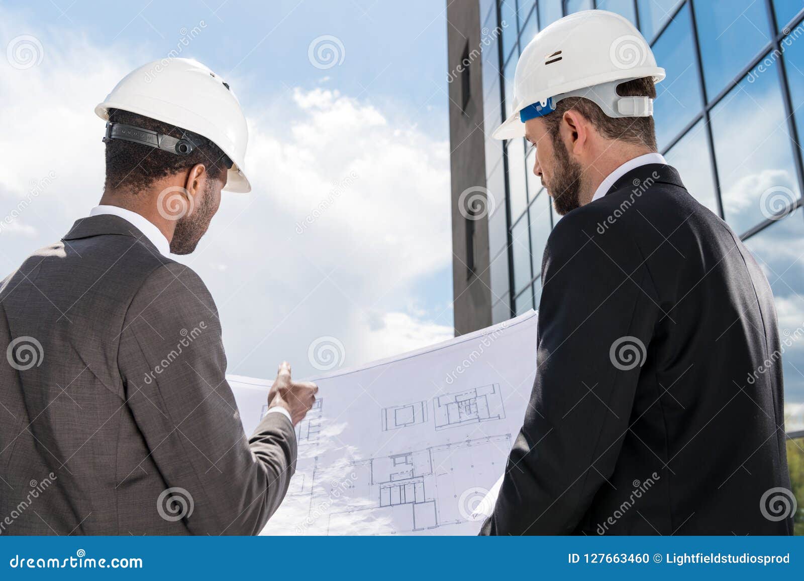 Back View of Professional Architects in Hardhats Working Stock Photo ...