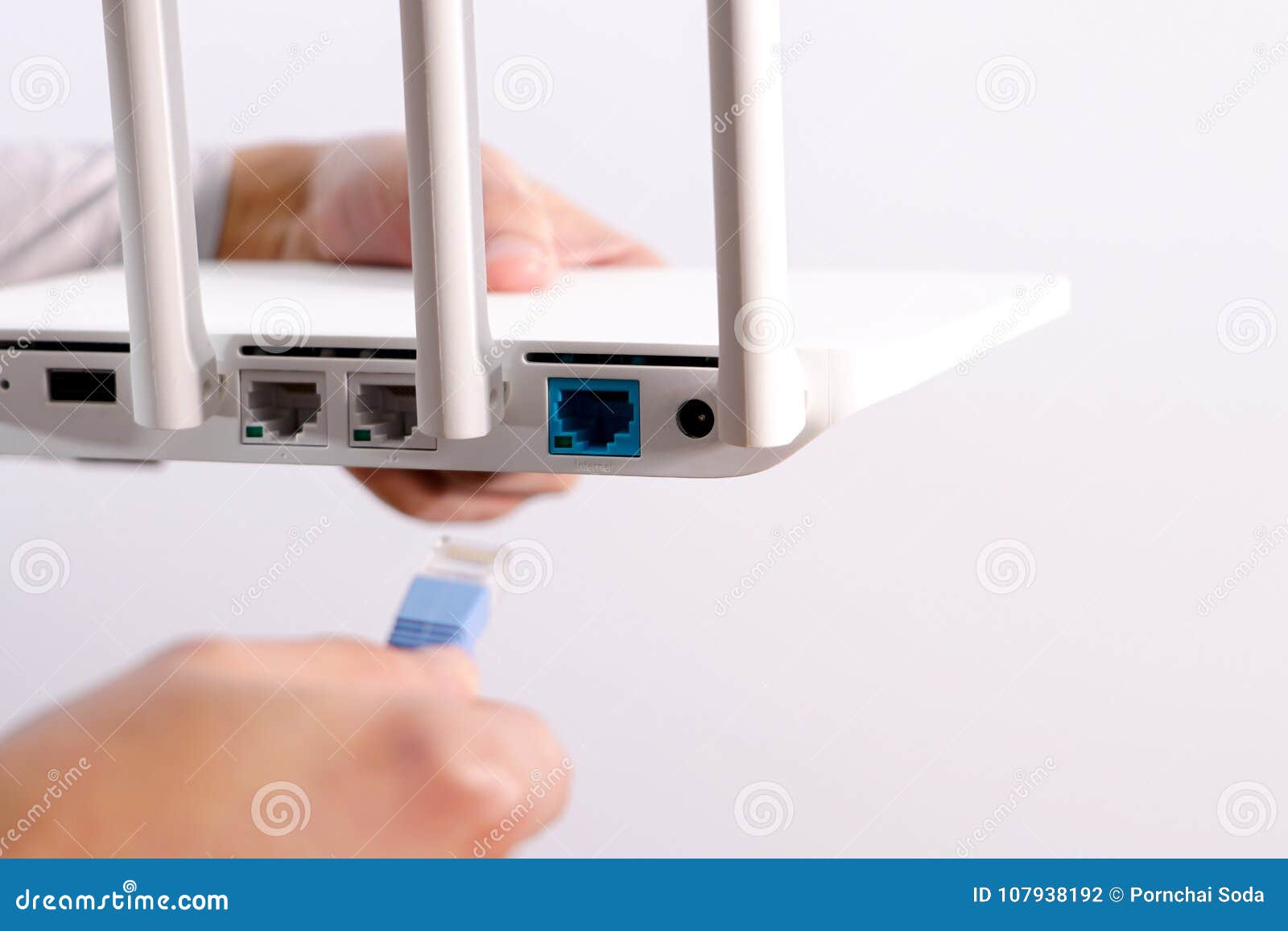 The Back View of Router Showing the Lan Internet Port, and the Hand is ...
