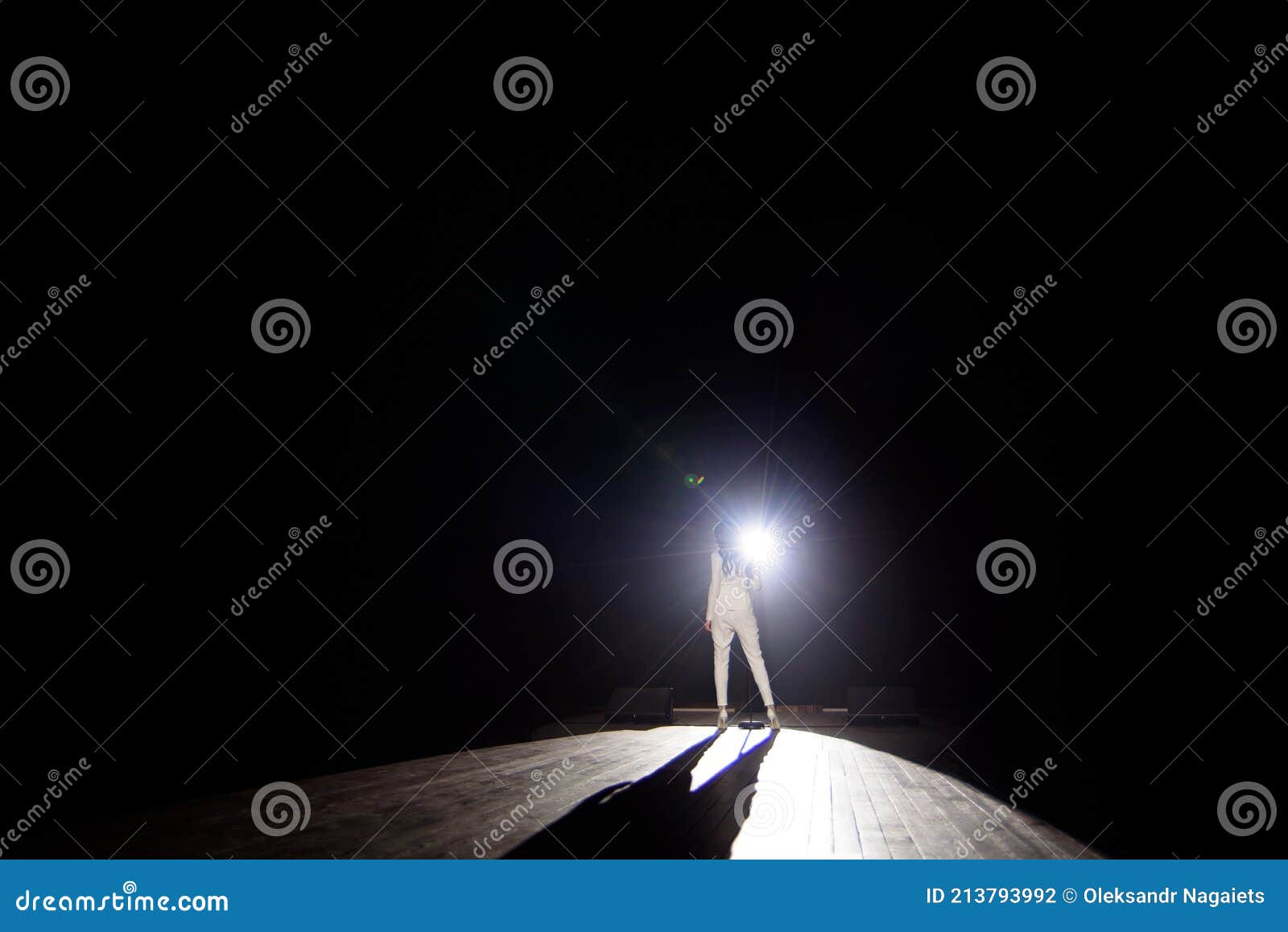 Back View of a Singer with Microphone Singing a Song on Stage in White ...