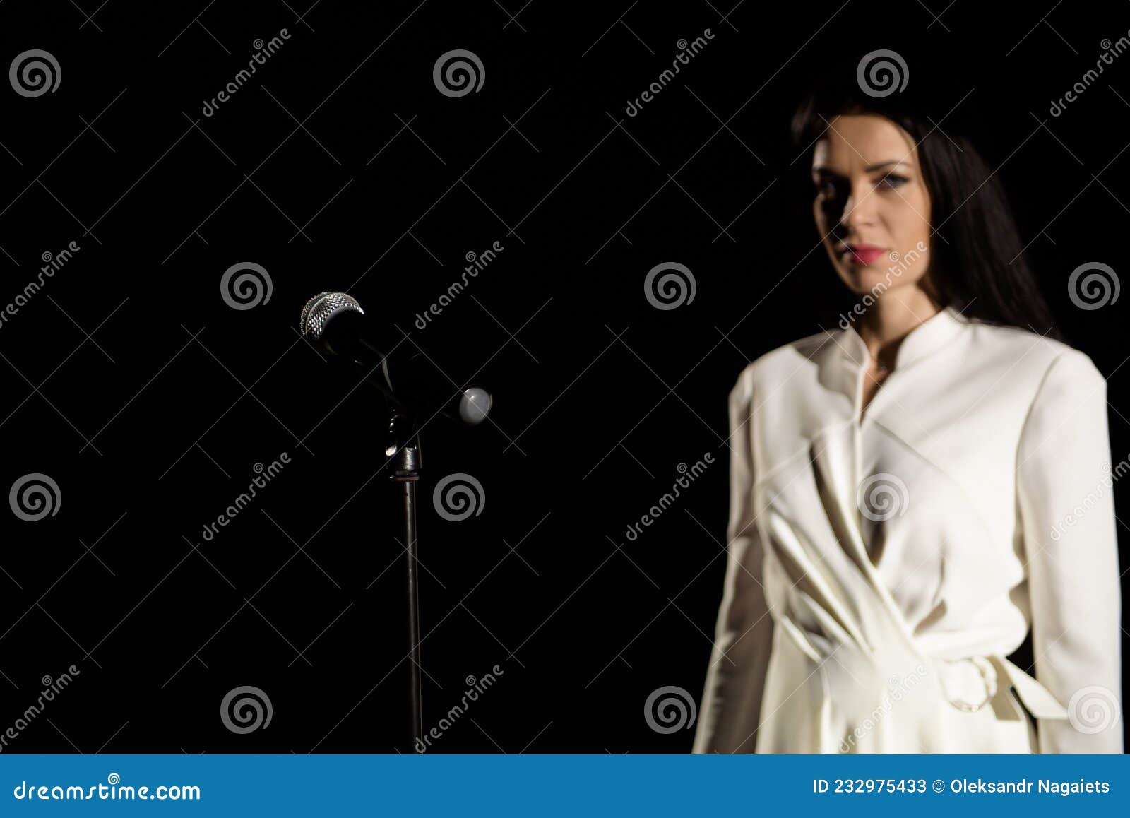 Back View of a Singer with Microphone Singing a Song on Stage in White ...