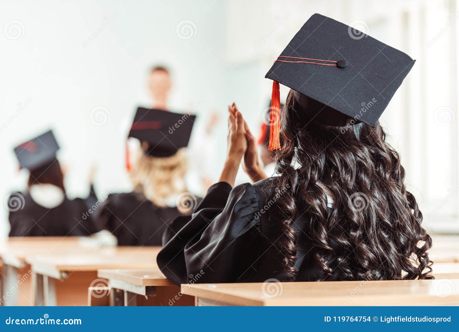 Back View of Student Girl in Graduation Costume Clapping Hands while ...
