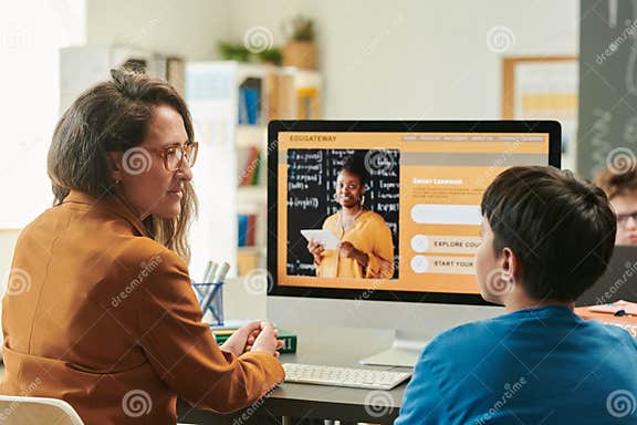 Back View of Teacher Using Computer with Student Stock Photo - Image of ...