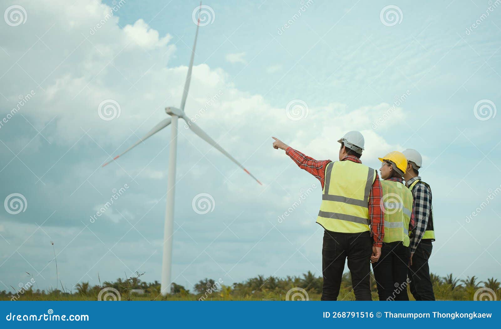 Back View of Three Engineers Discussing and Progress Check Wind Turbine ...