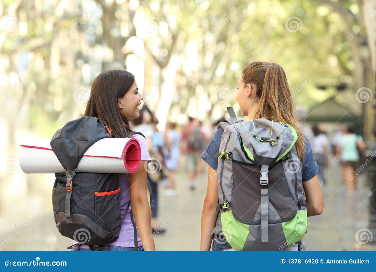 Back View of Two Backpackers Walking in the Street on Vacation Stock ...