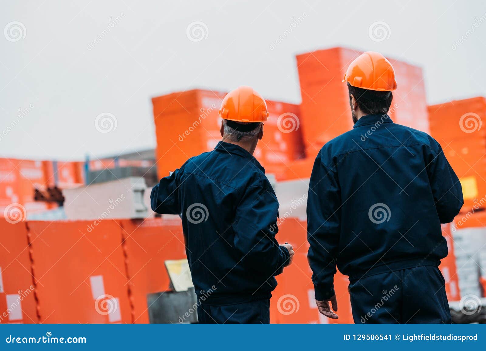 Back View of Two Builders in Helmets Working Outside Stock Image ...