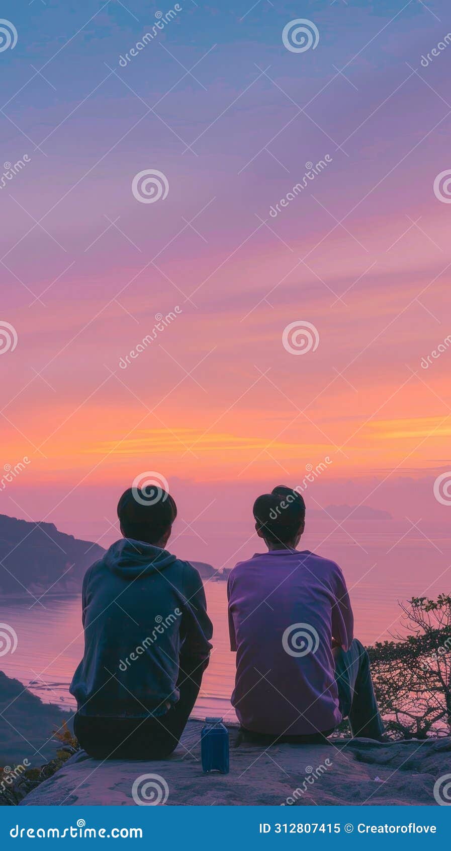 Back View of Two Friends Sitting on Mountain Looking at Sunset Stock ...
