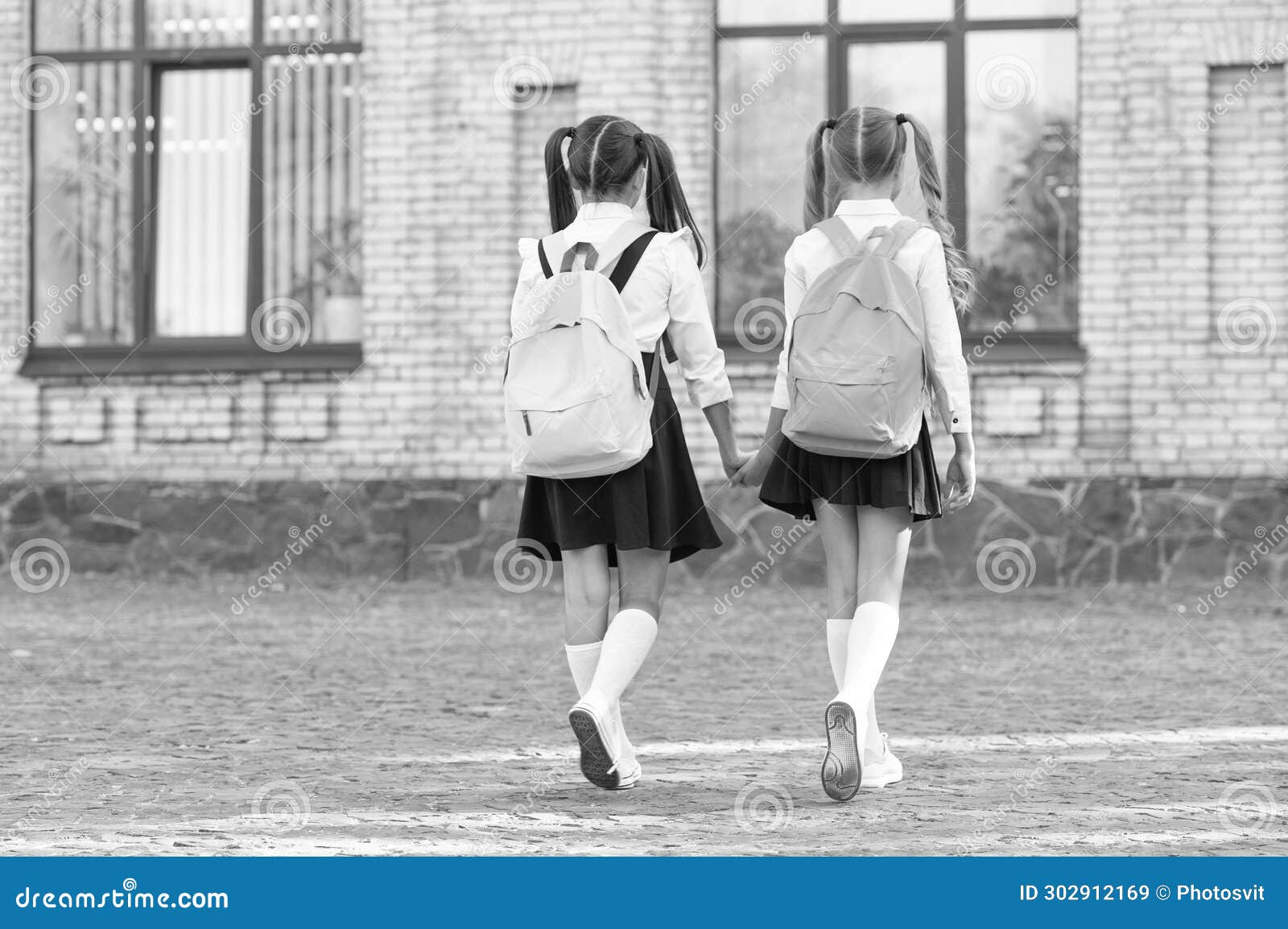 Back View of Two Sisters with School Backpack Walking Together Outdoor ...