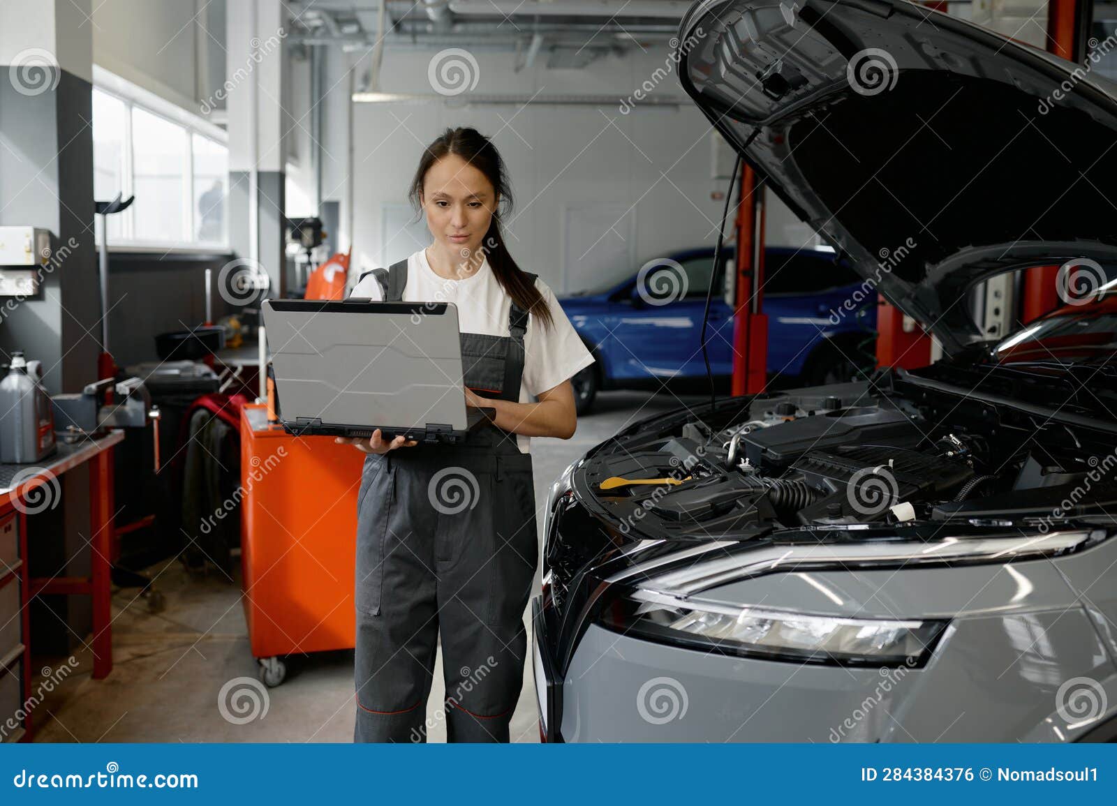 Back View on Woman Auto Engineer Doing Computer Diagnostic Stock Photo ...