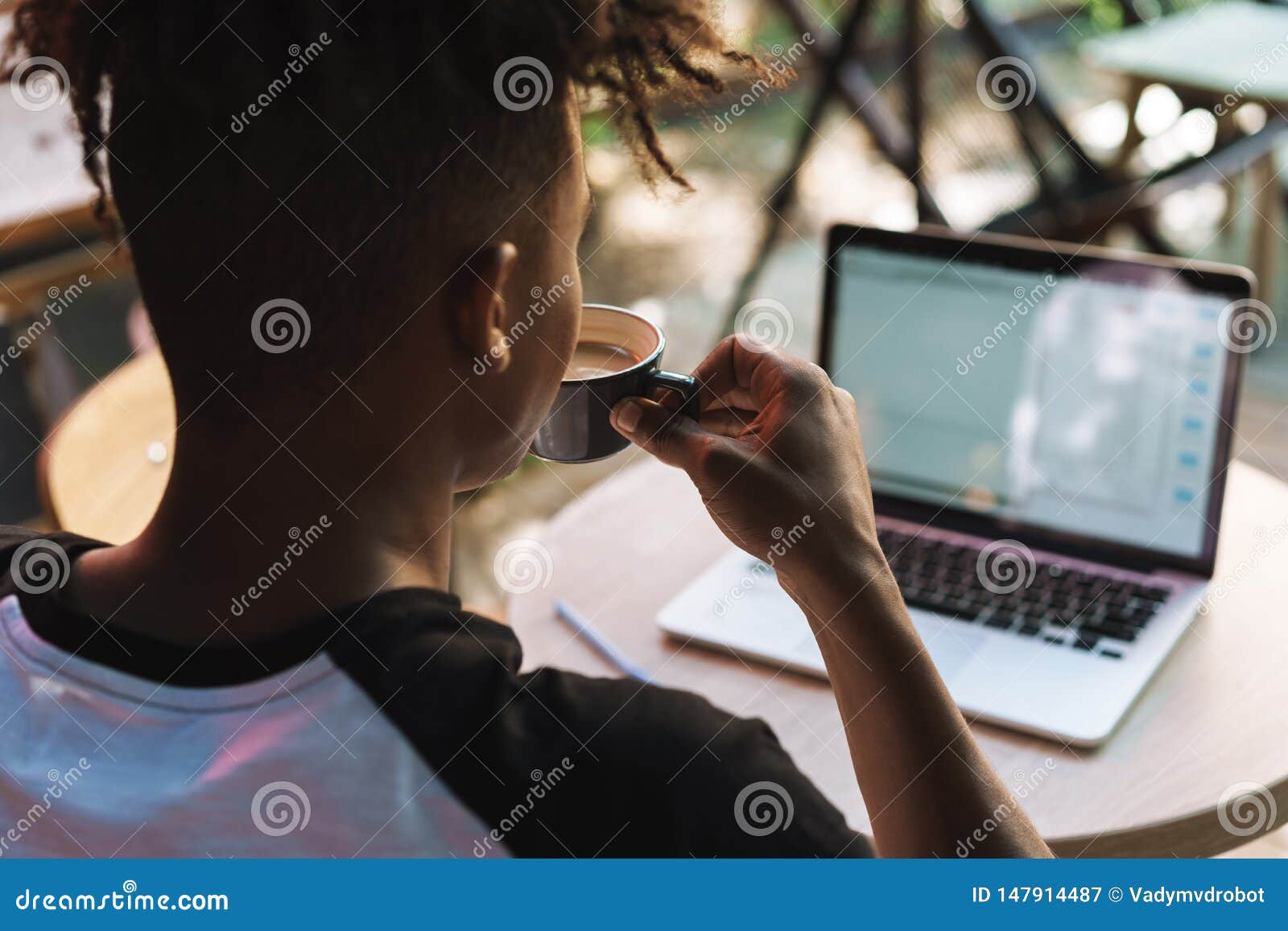 Back View of a Young African Man Using Laptop Computer Stock Image ...