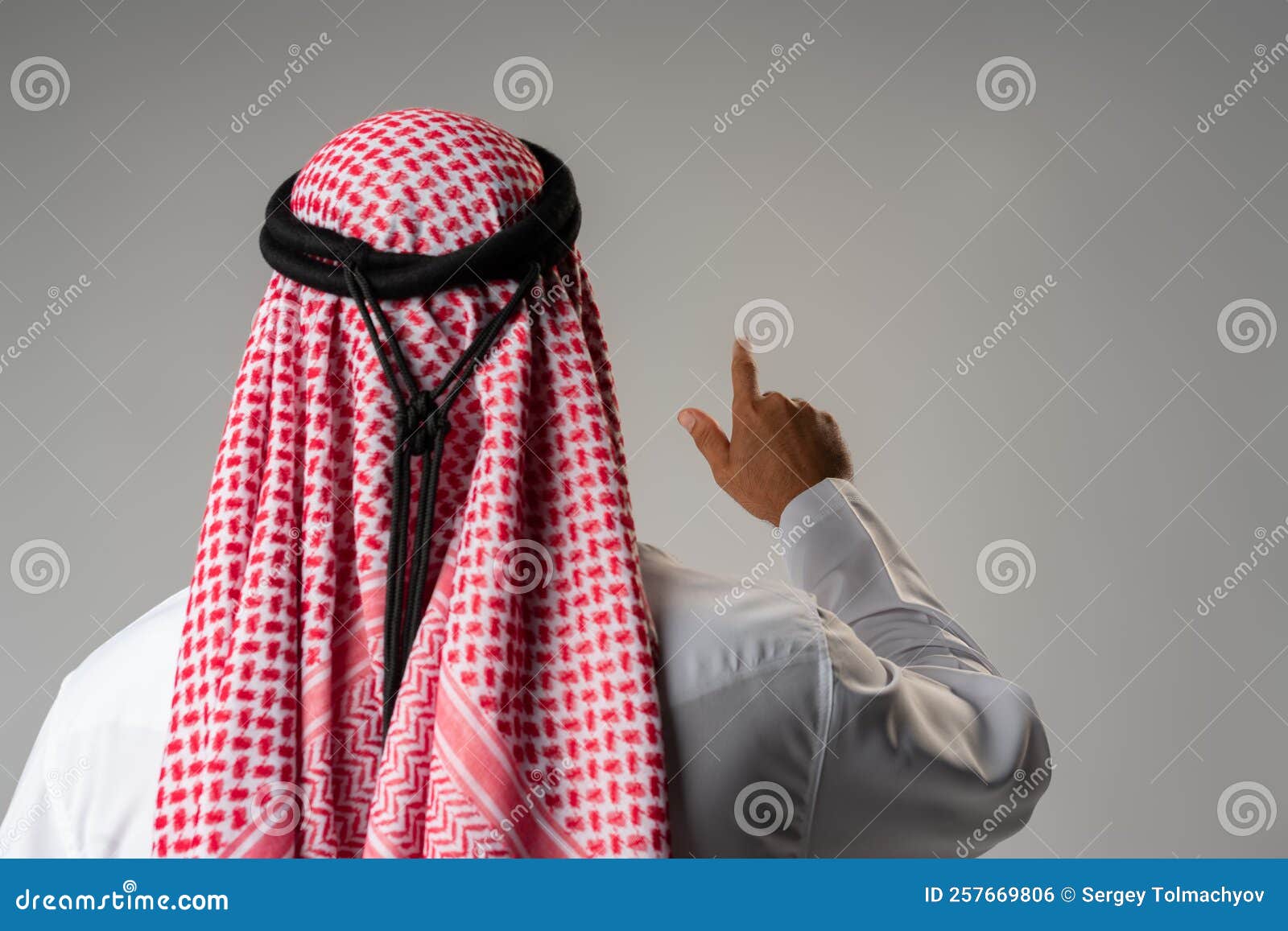 Back View of Young Arab Man Standing on Gray Background Stock Photo ...