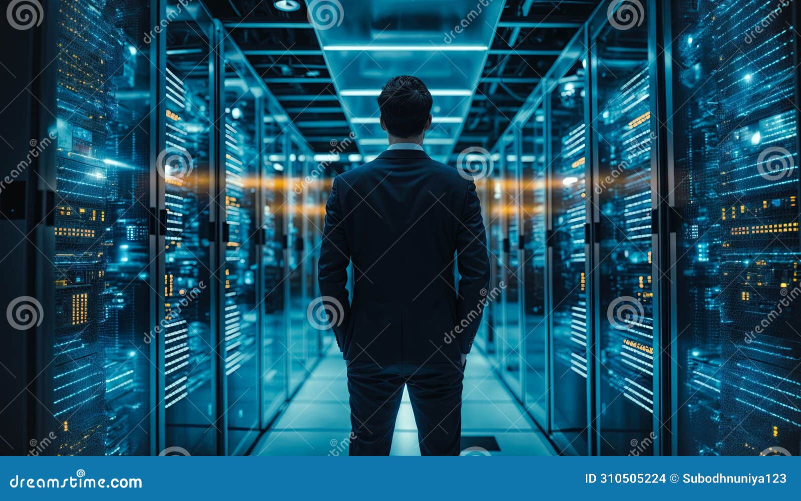 Back View of Young Businessman Standing in Server Room and Looking at ...