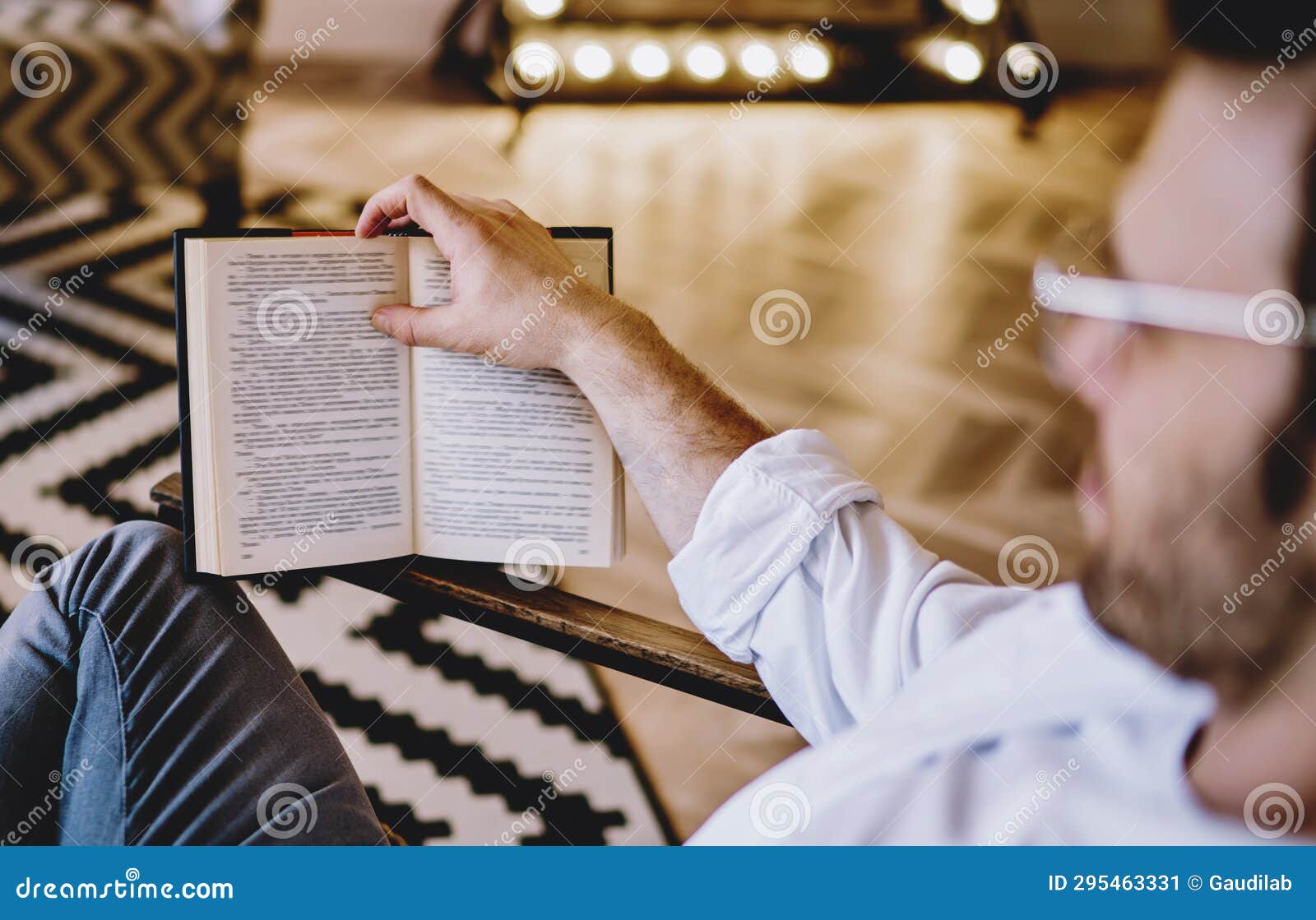 Back View of Young Clever Man Sitting in Chair and Reading Book with ...
