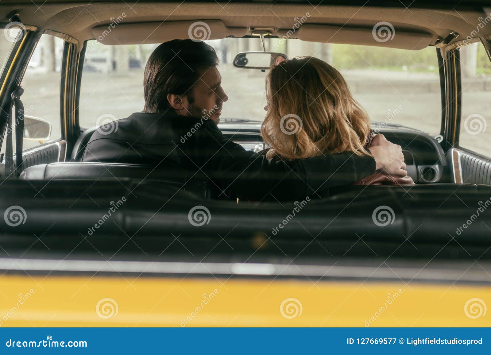 Back View of Young Couple Embracing and Looking at Each Other Stock ...