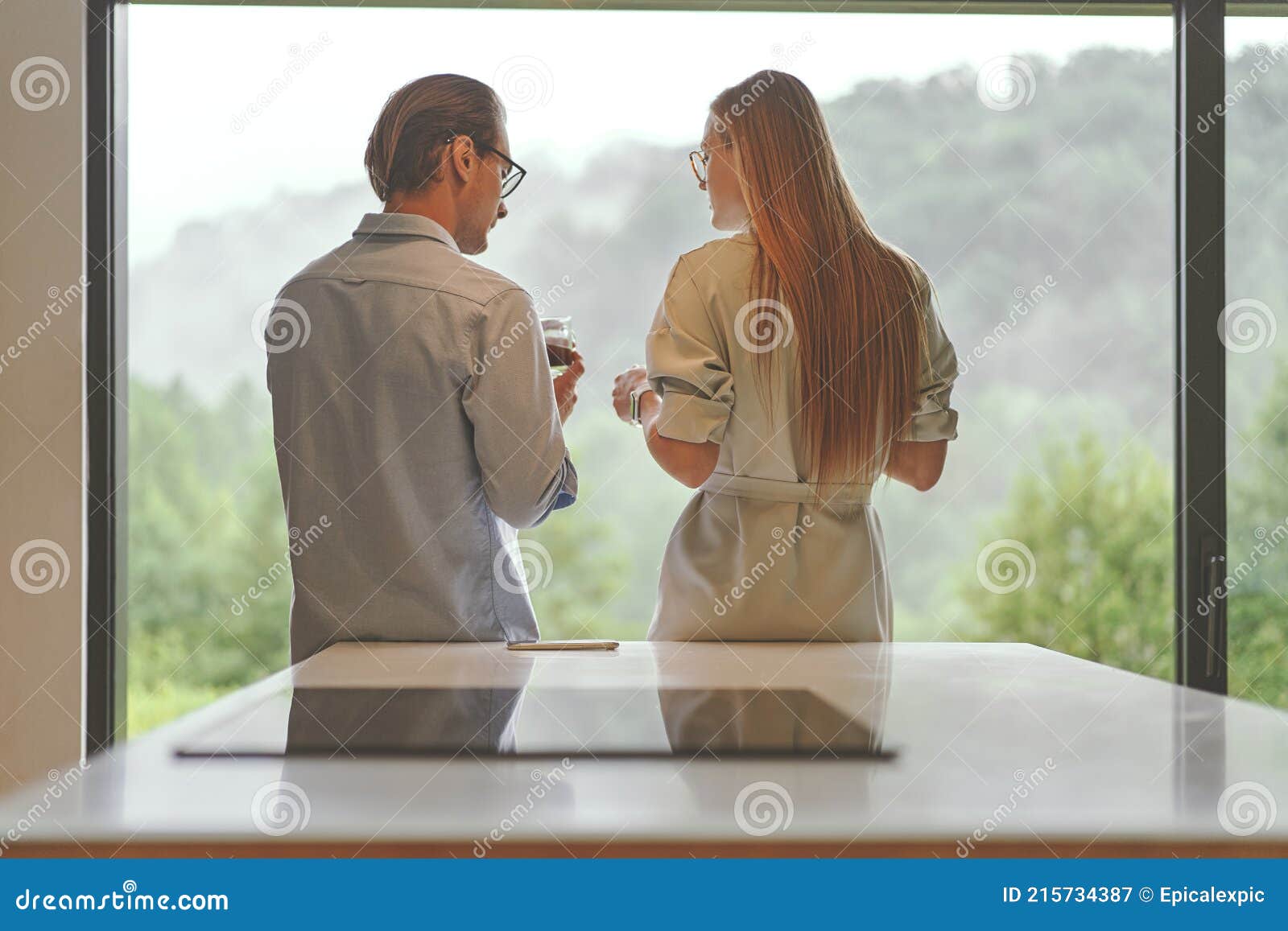 Back View of Young Family Couple Drinking Coffee on the Modern Kitchen ...