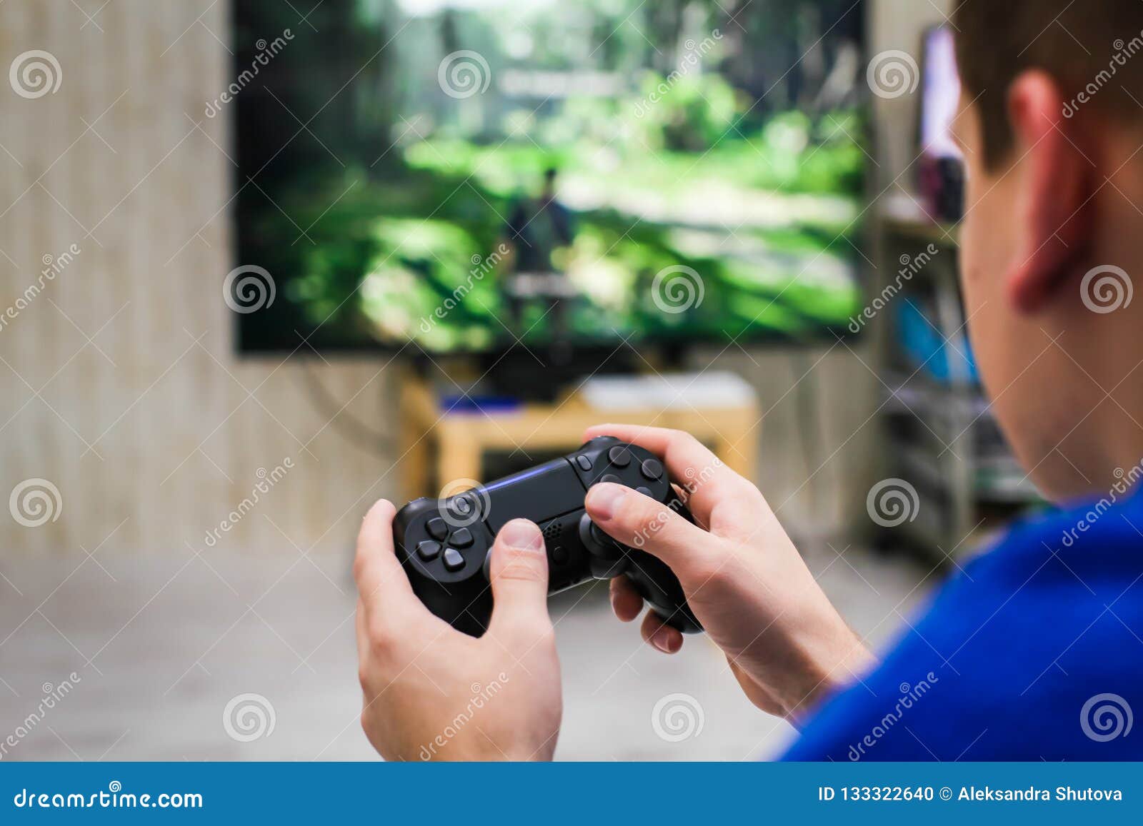 Back View of Young Gamer Playing Video Game Using His Controller Stock ...