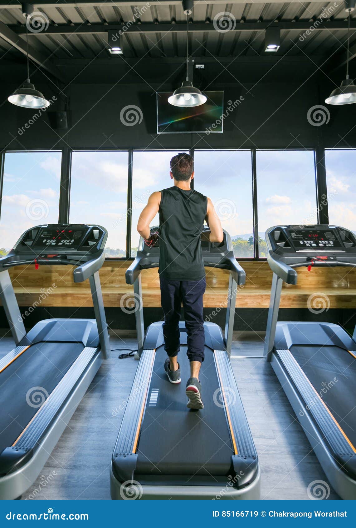 Back View of Young Man Athlete with Running on Treadmill in Gym. Stock ...