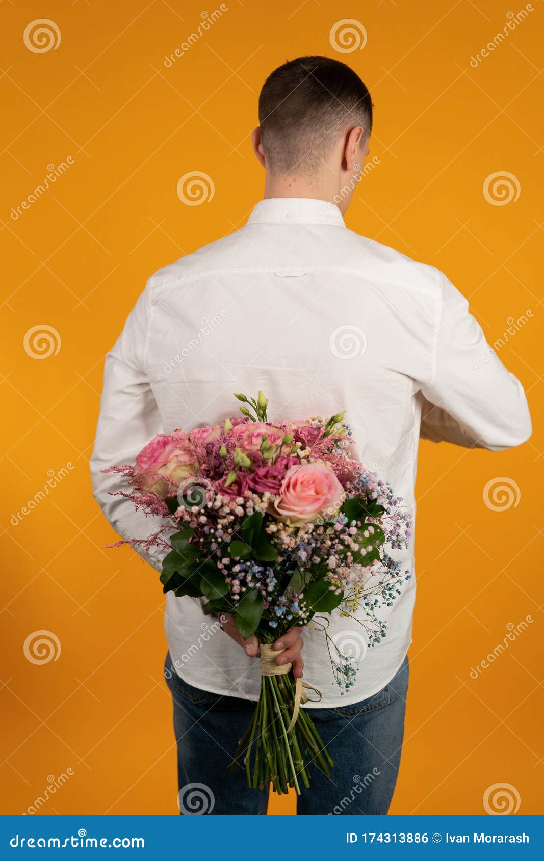 Back View of Young Man Holding Flowers Isolated on Yellow Background ...