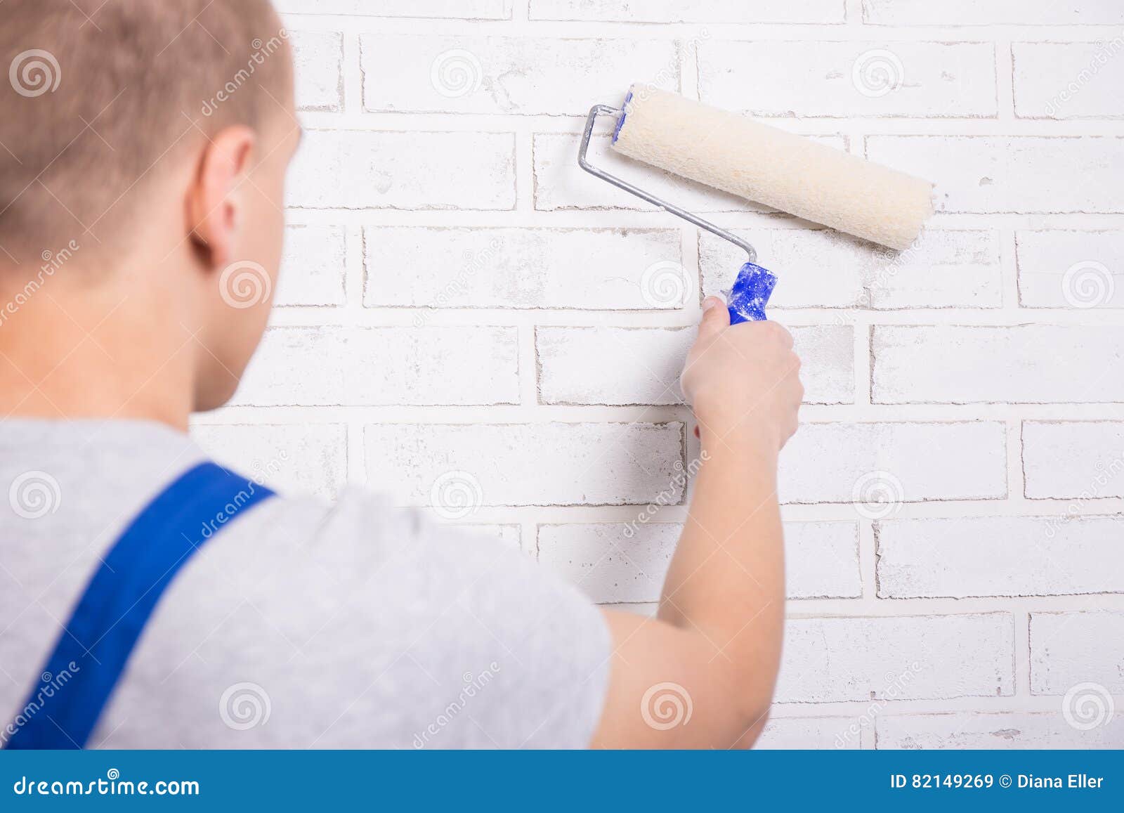 Back View of Young Man Painter in Workwear Painting Brick Wall W Stock ...