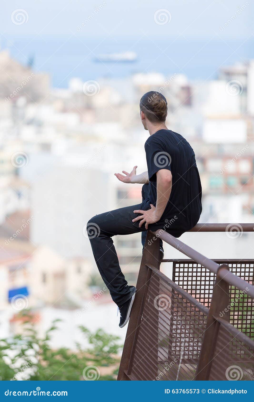 Back View of Young Man Sitting on Railings Stock Image - Image of ...