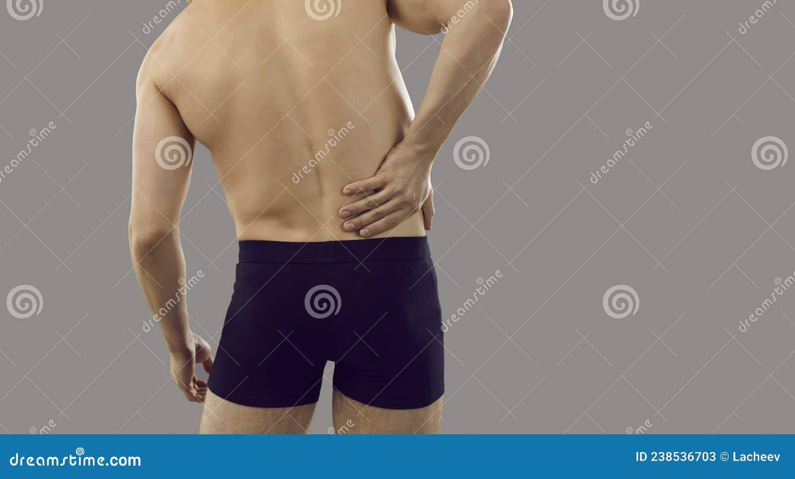Back View of Young Man Suffering from Pain in His Right Side and ...