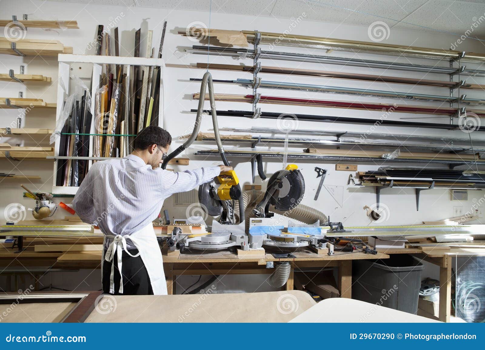 Back View of Young Man Using Circular Saw in Workshop Stock Photo ...