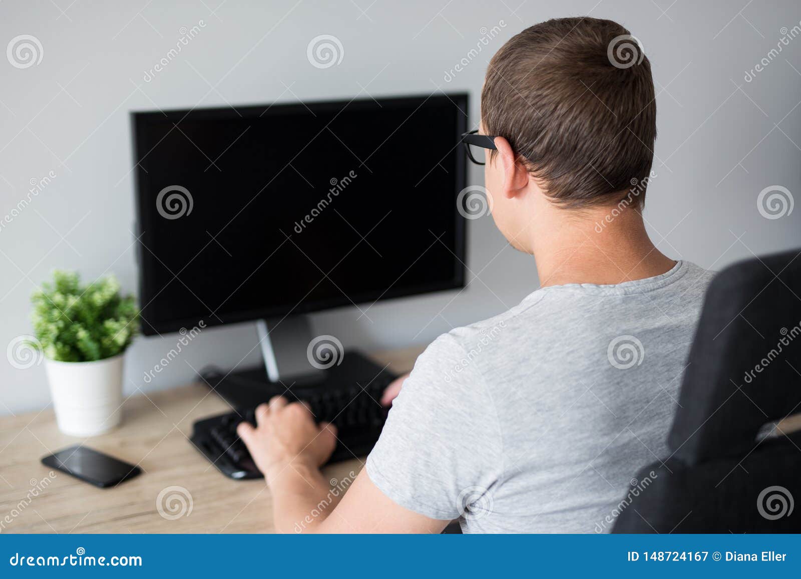 Back View of Young Man Using Computer with Blank Screen Stock Image ...