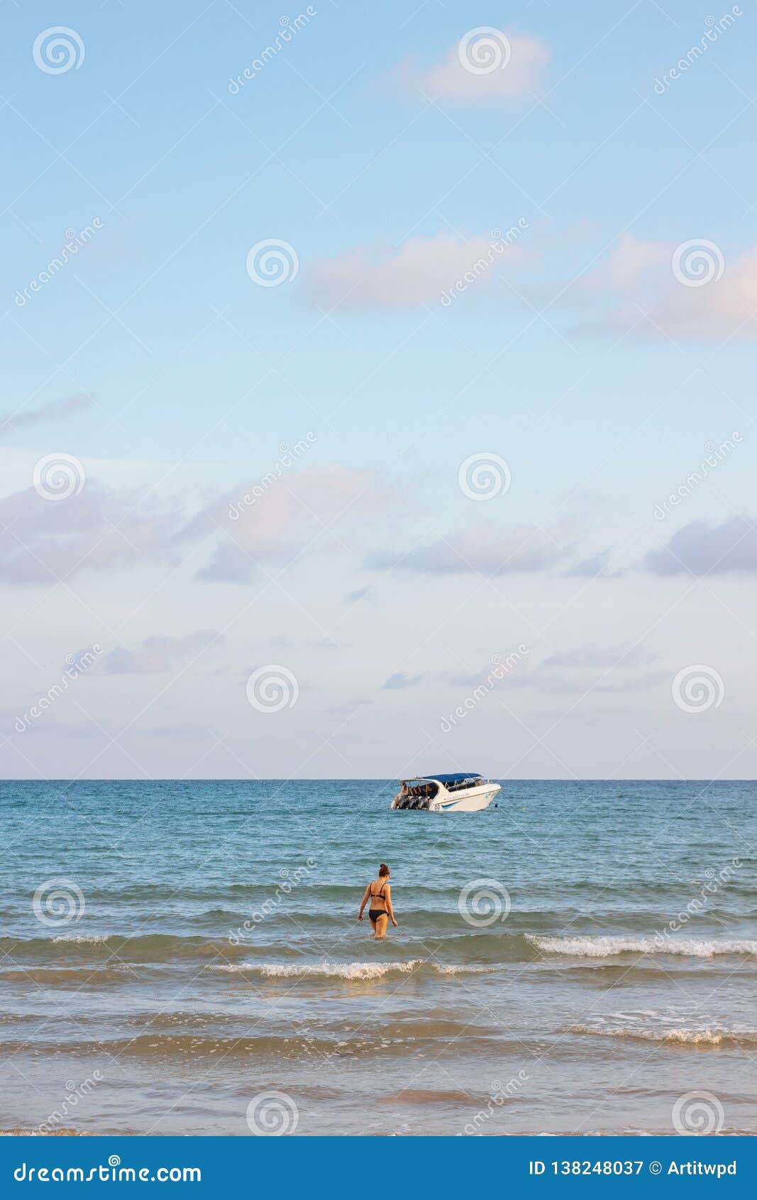 Back Of A Woman Wearing Bikini Standing In The Sea With Speed Boats And